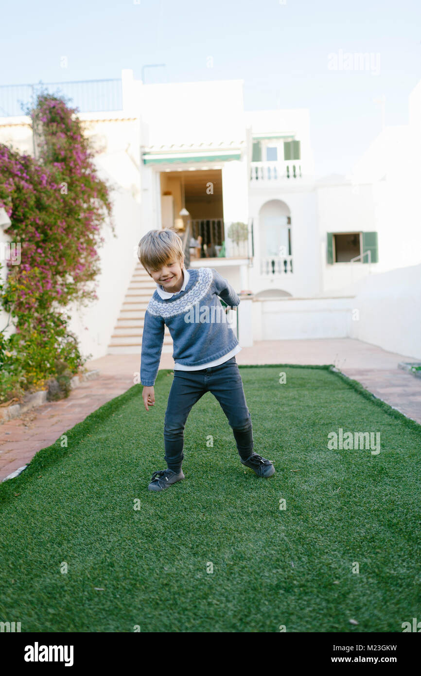 children playing in the home garden on green grass in spring Stock ...