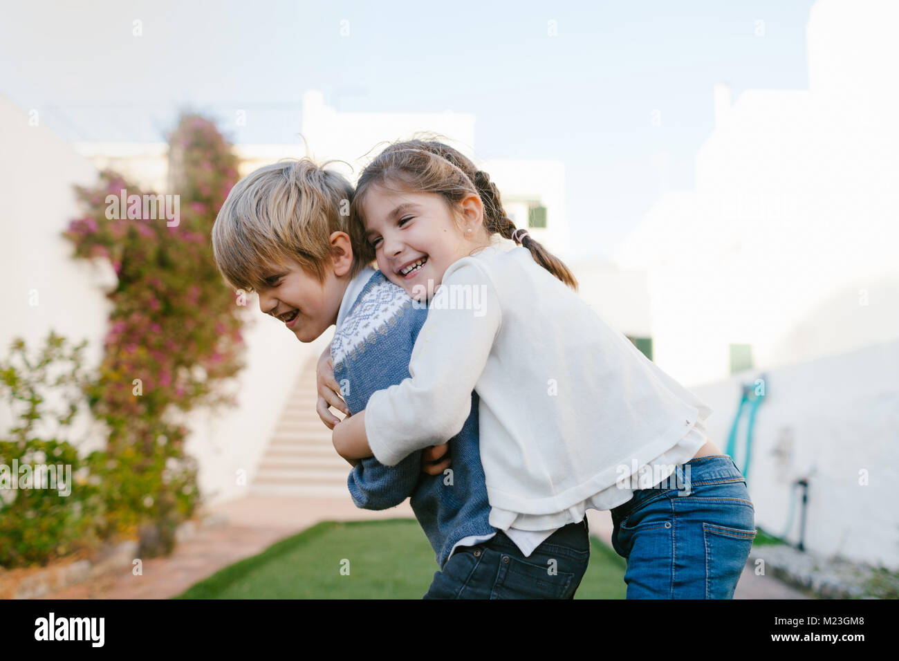 children playing in the home garden on green grass in spring Stock ...