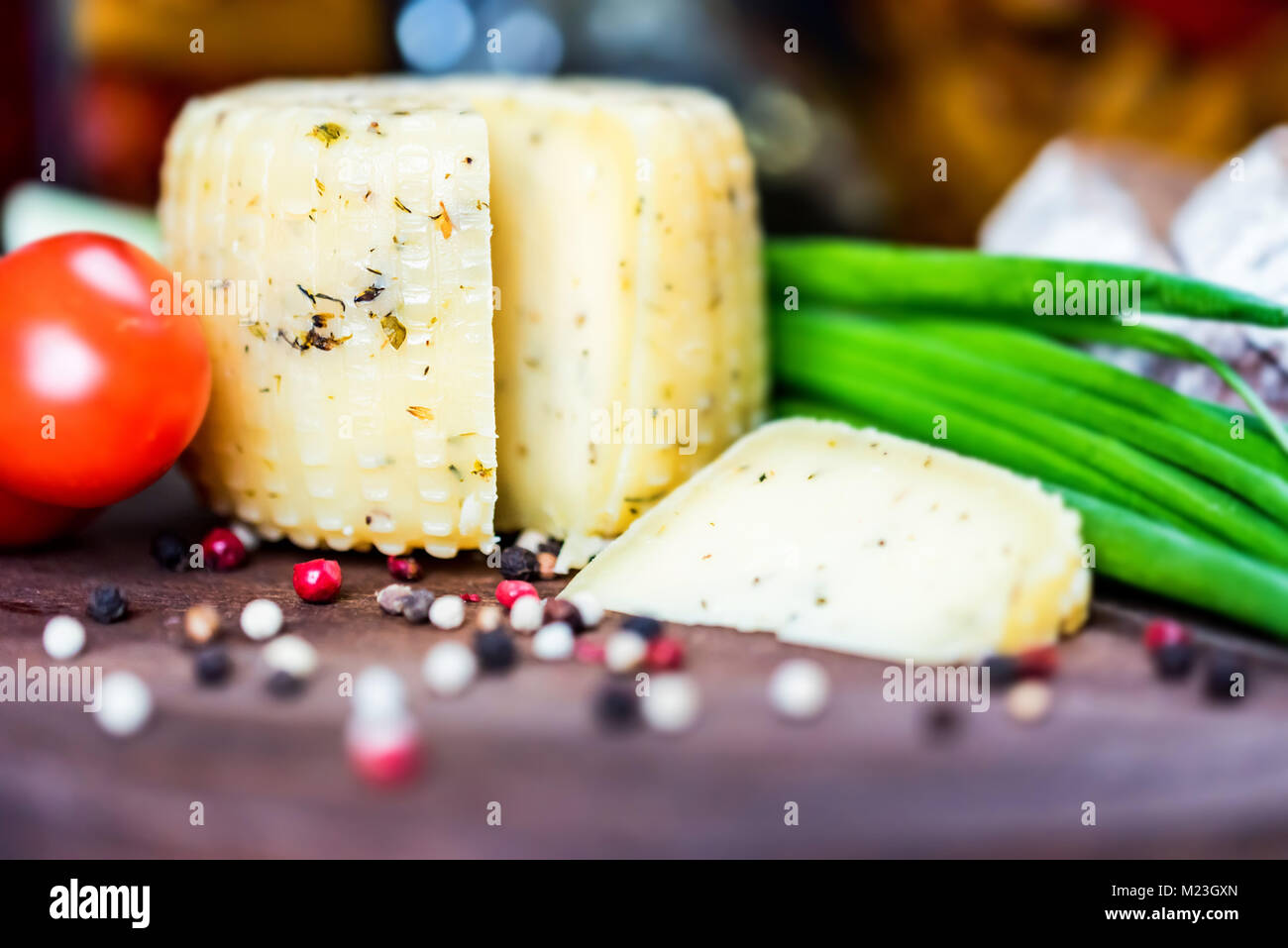 Rustic cheese with herbs, pepper and vegetables Stock Photo - Alamy