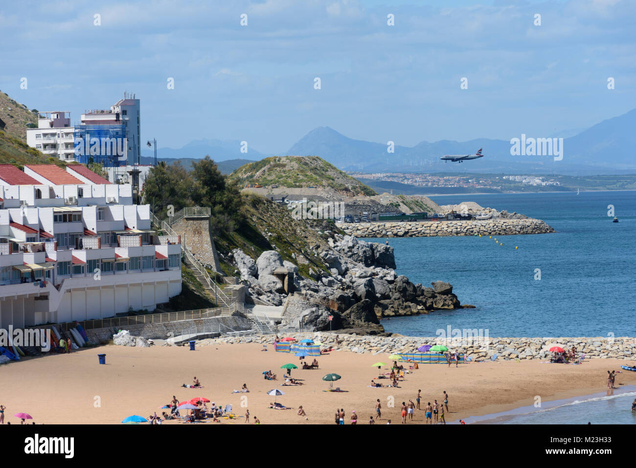 Gibraltar, Catalan Bay Beach and landing aeroplane Stock Photo - Alamy