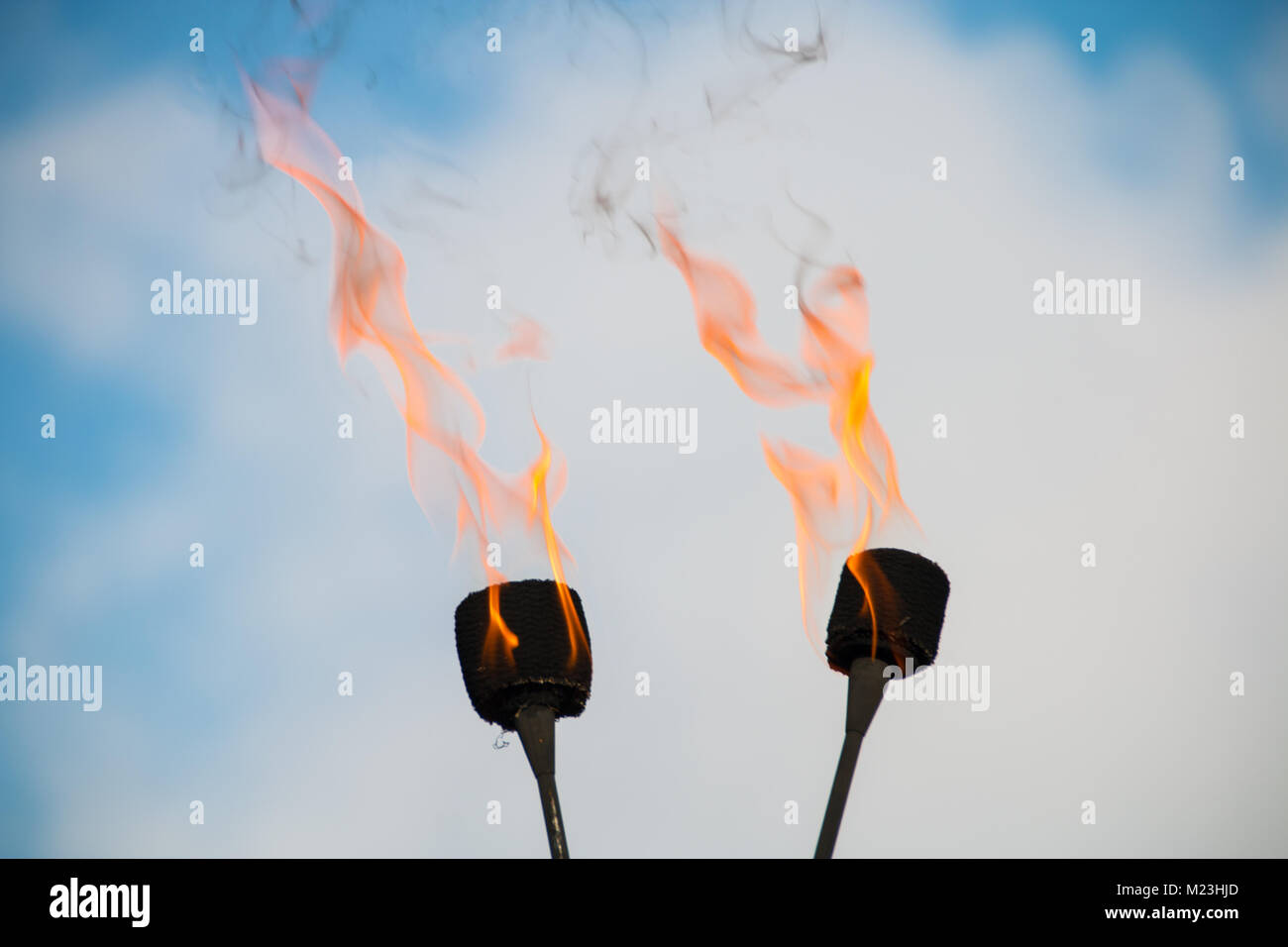 Two burning torches which used by fire spitters Stock Photo - Alamy