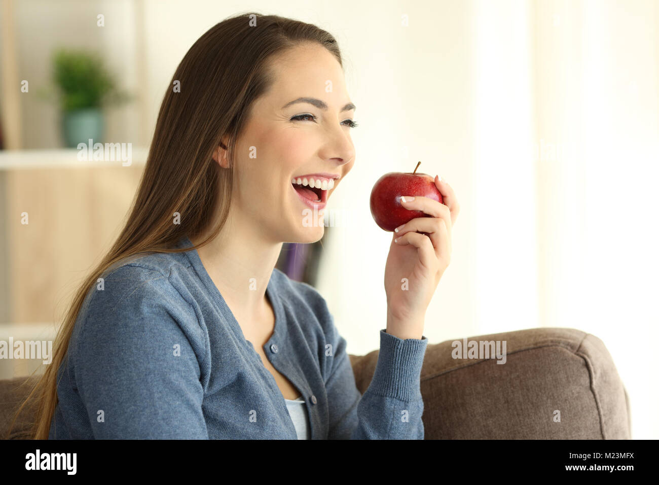 Young woman apple in mouth hi-res stock photography and images - Alamy