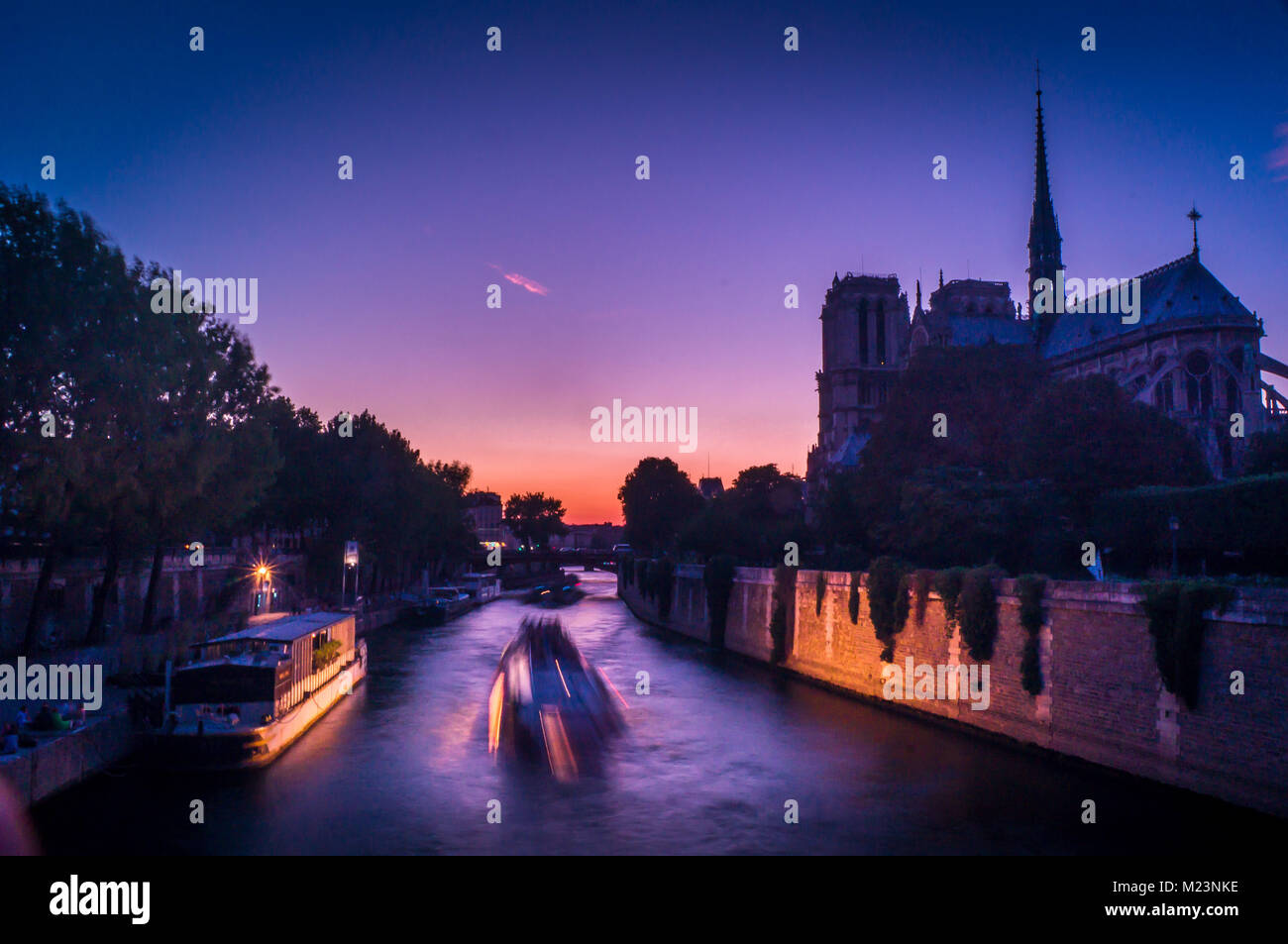 Purple sunset at dusk over Paris and Notre Dame de Paris Stock Photo ...
