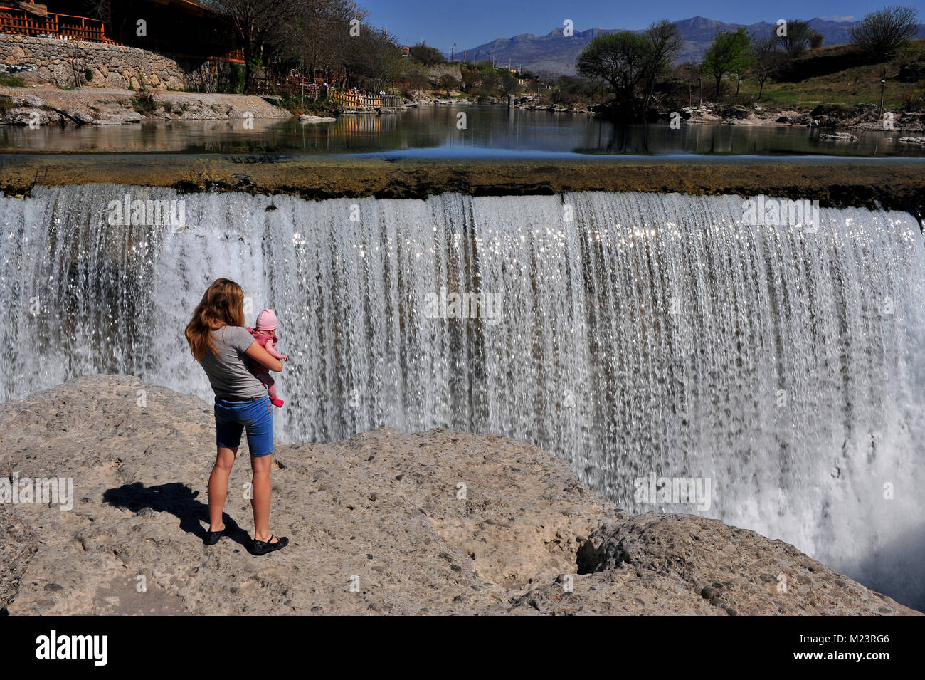 Woman standing back waterfall hi-res stock photography and images - Alamy
