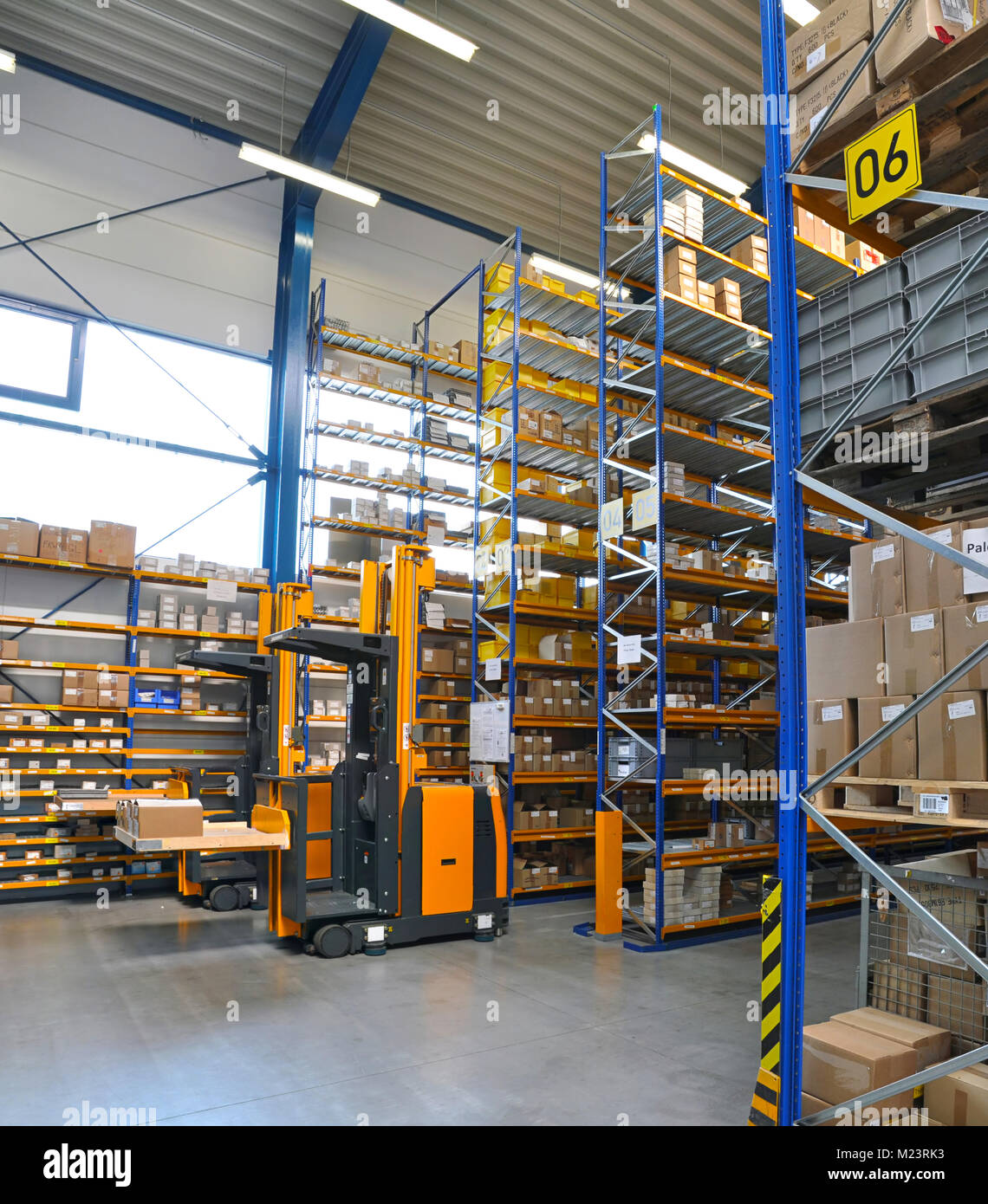 forklift truck in a warehouse of a commercial enterprise, high racks ...