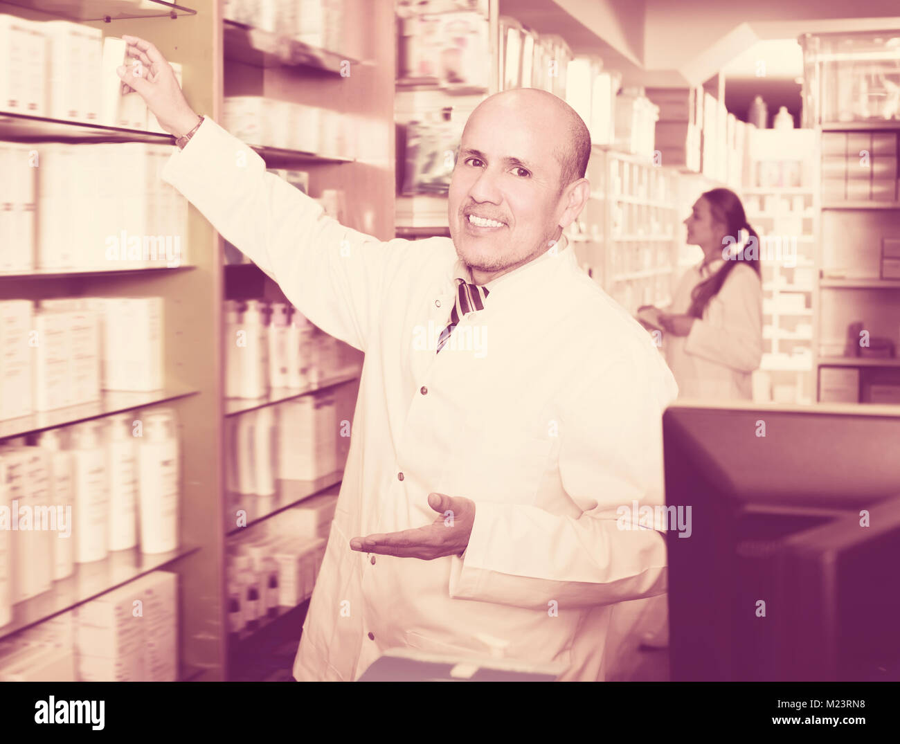 Happy pharmacist and pharmacy assistant helping in drugstore Stock ...