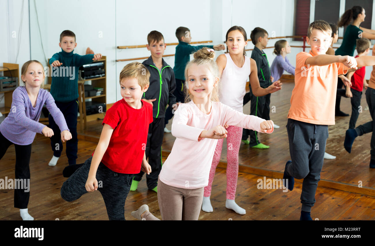 Glad children studying modern style dance in class Stock Photo - Alamy