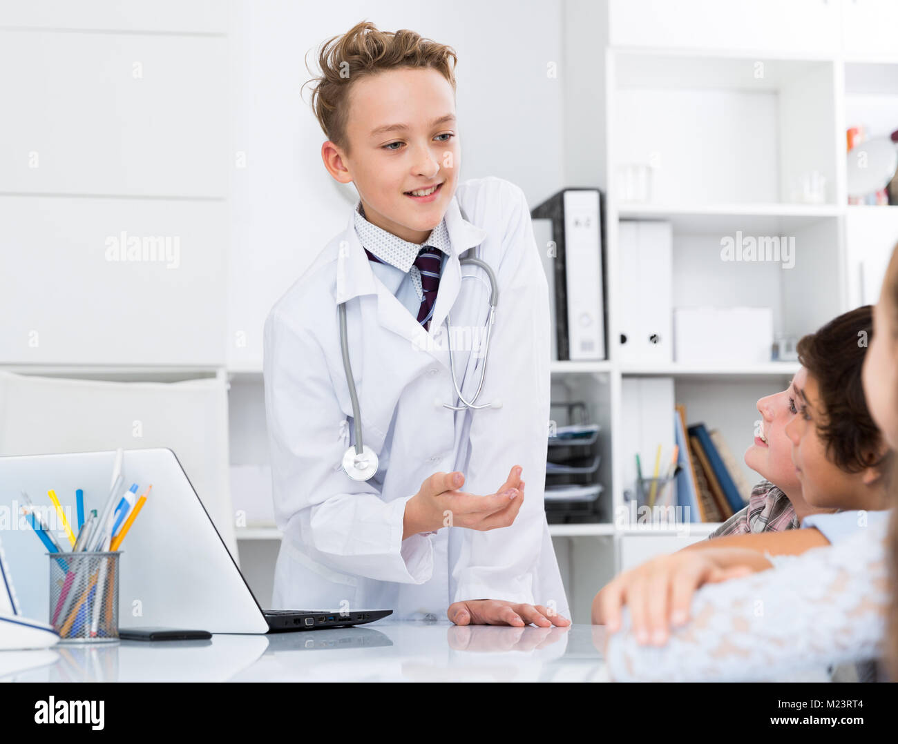 Medical brother boy in medical center with stethoscope with visitors ...