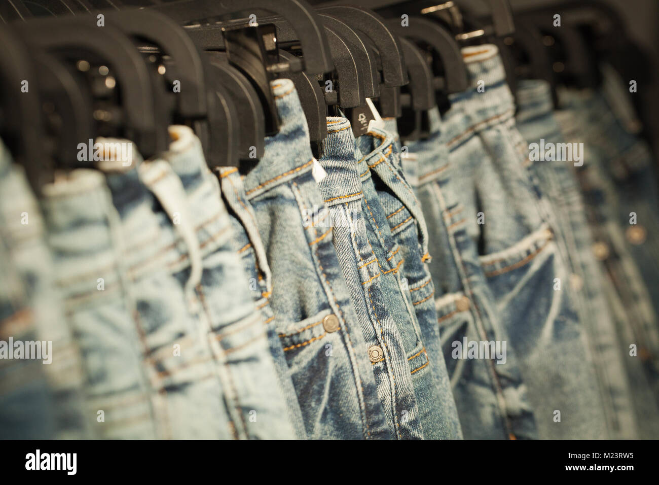 jeans in a clothes rail inside a store Stock Photo - Alamy