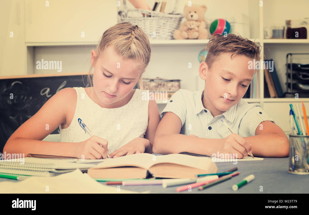 Brother with sister are doing homework at home Stock Photo - Alamy