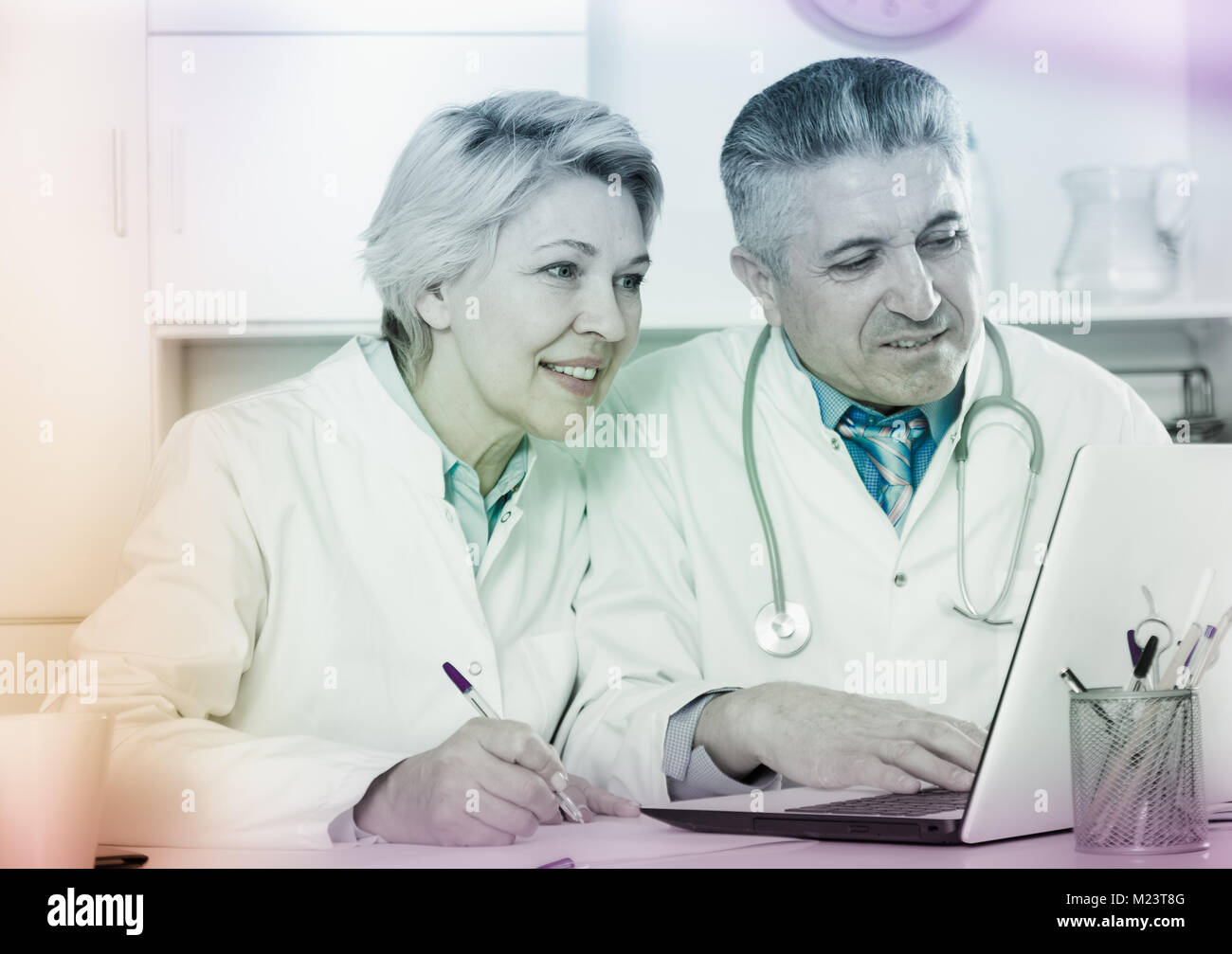 Doctor and nurse check patient data in hospital computer database Stock ...
