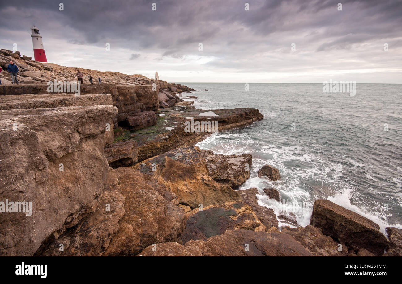Waves break on the rocks of the Isle of Portland, with Portland Bill ...