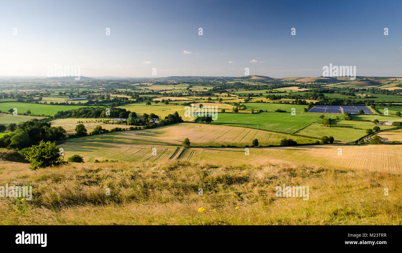 Rolling chalk hills rise over agricultural fields and pasture in North ...