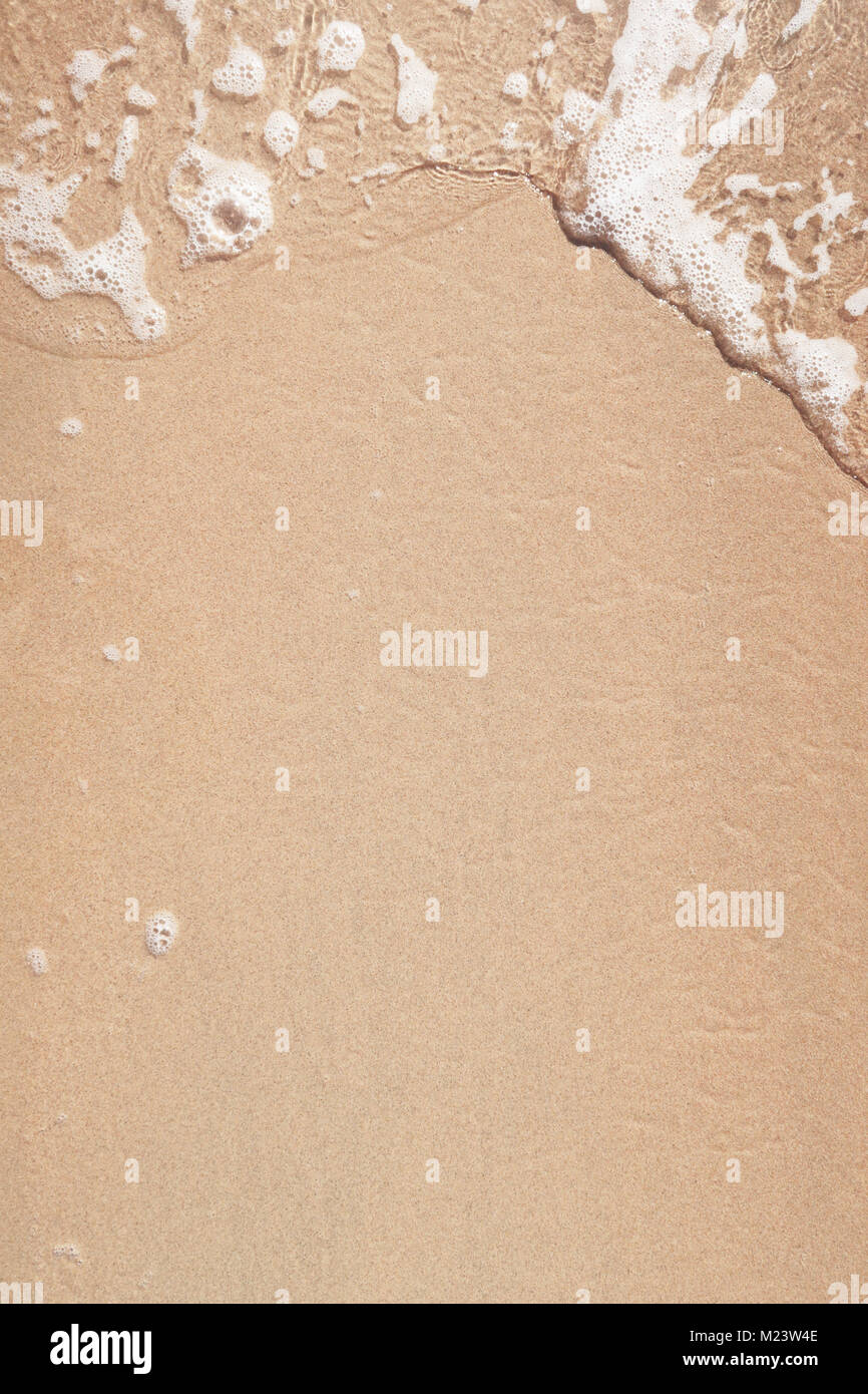 Transparent soft wave on sandy beach Stock Photo - Alamy