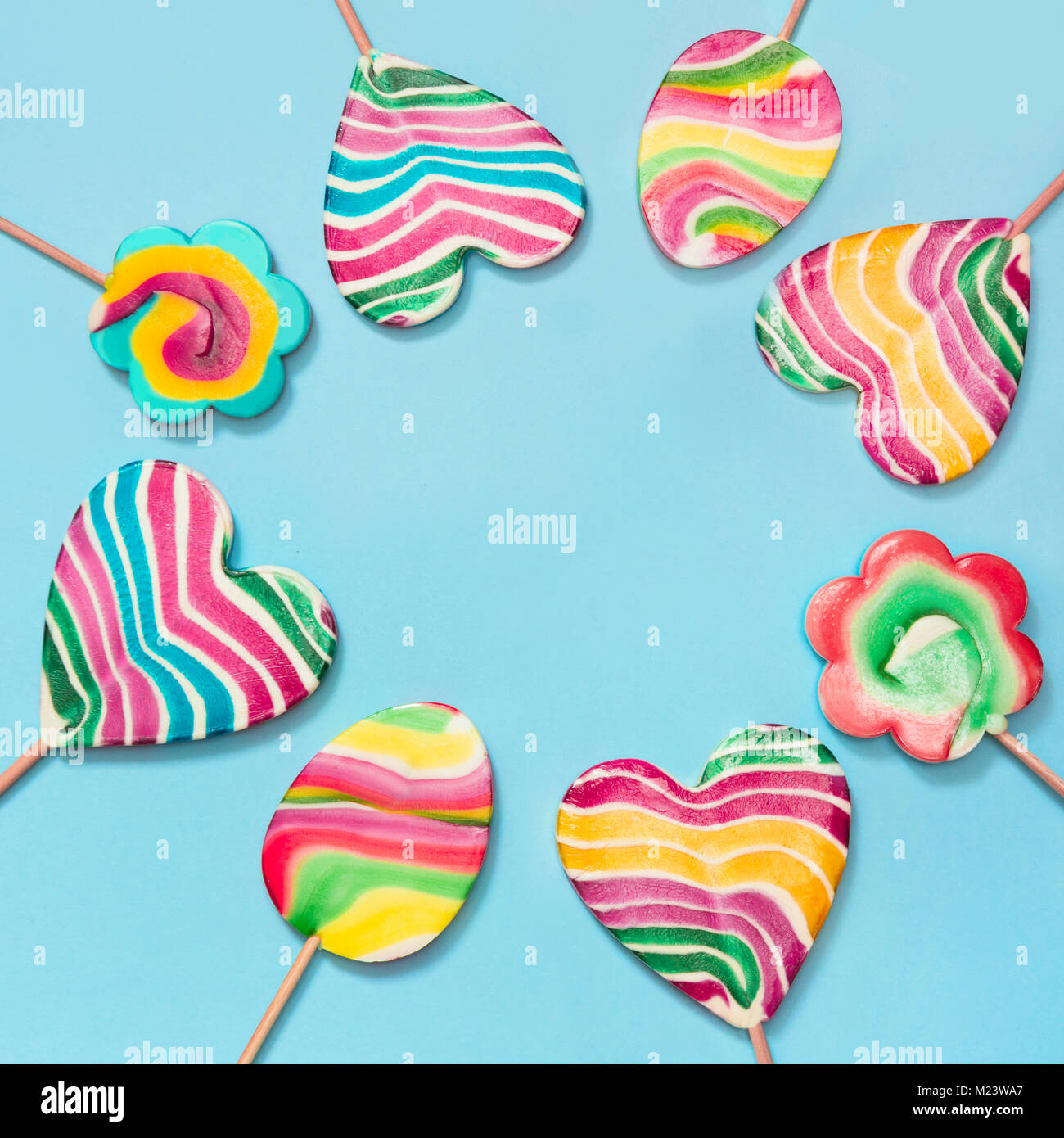 Set of rainbow colorful candy isolated on blue background. Top view ...