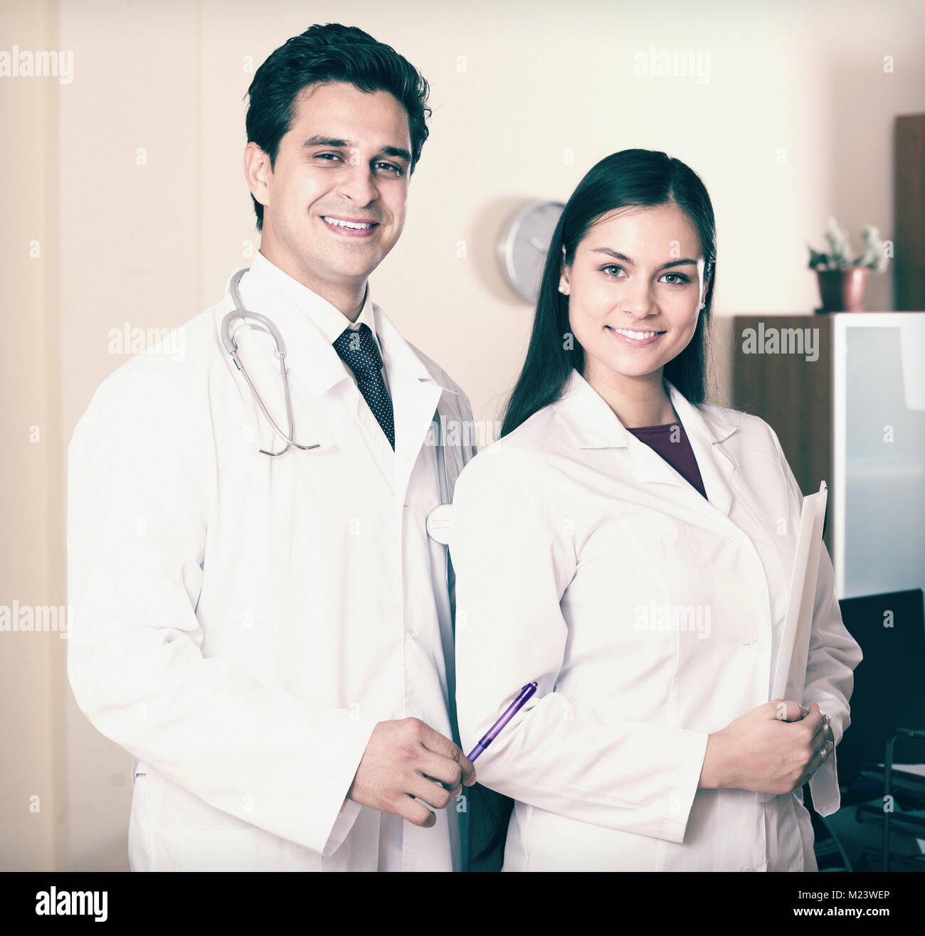 Portrait of two professional doctors smiling Stock Photo - Alamy