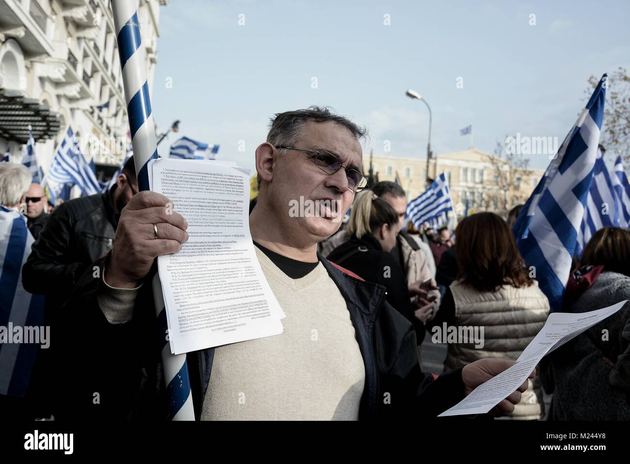 Protesters hold greek flag during hi-res stock photography and images ...