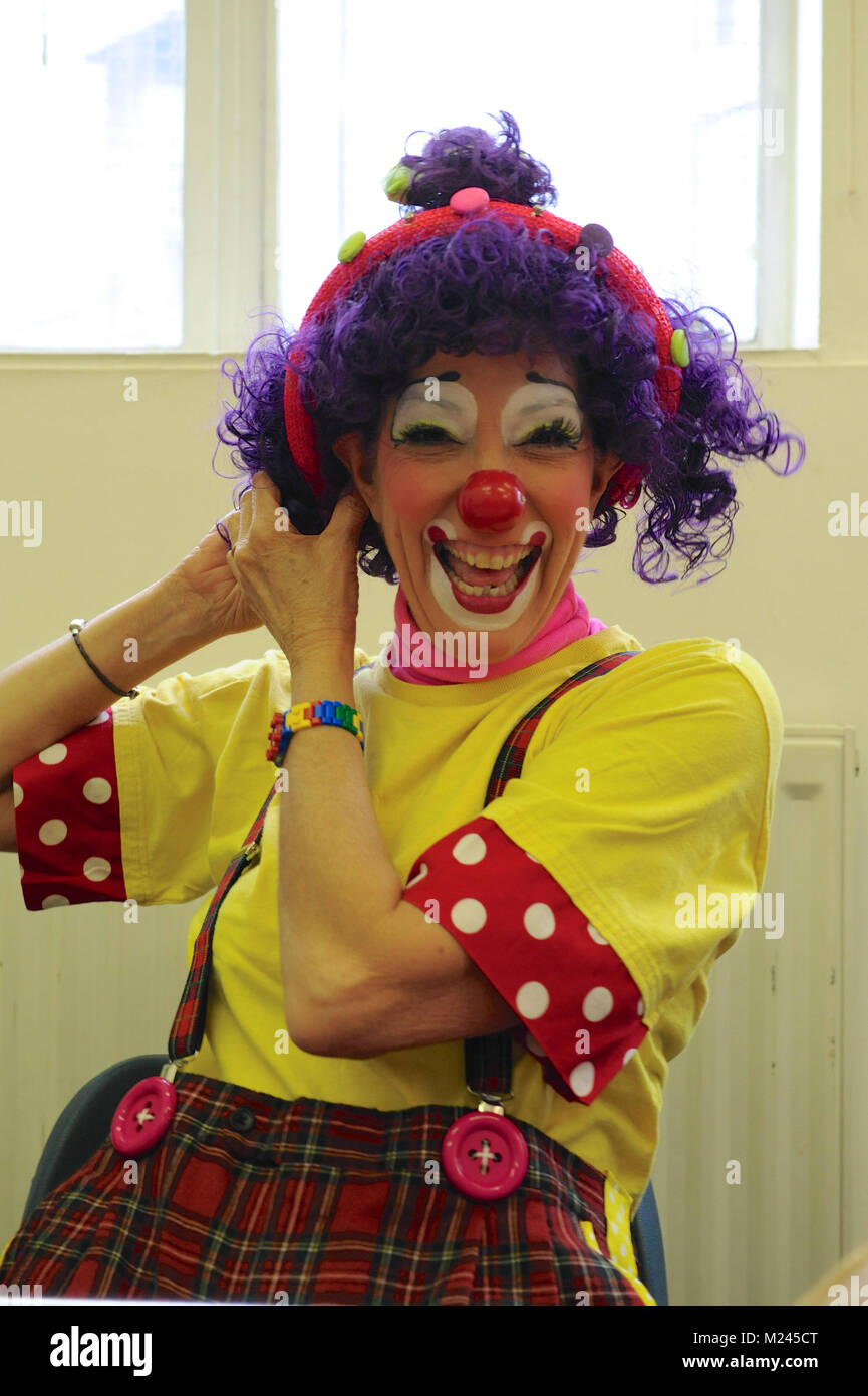 Lovely Buttons the Clown adjusting her wig as the final part of her ...
