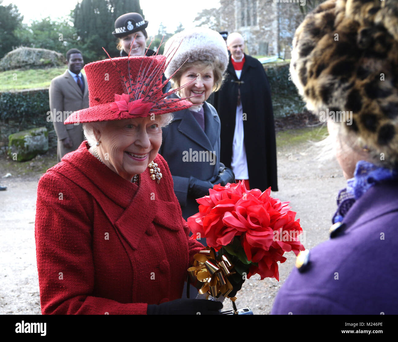 HM Queen Elizabeth II is given bunches of flowers after attending the ...