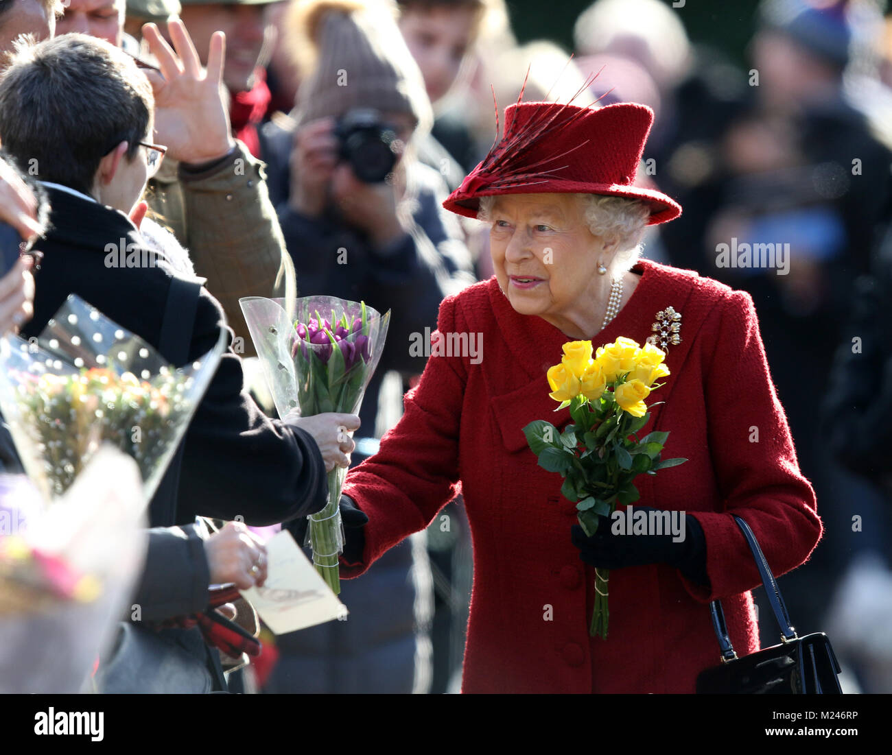 HM Queen Elizabeth II is given bunches of flowers after attending the ...