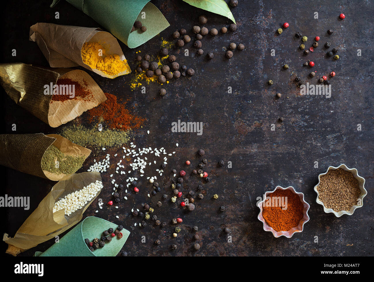 Different food spices scattered on a dark surface Stock Photo - Alamy