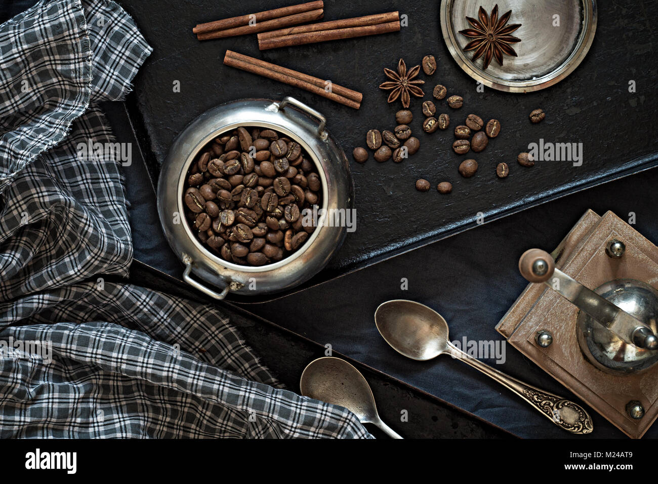Coffee beans on a black baking sheet in a metal container Stock Photo ...