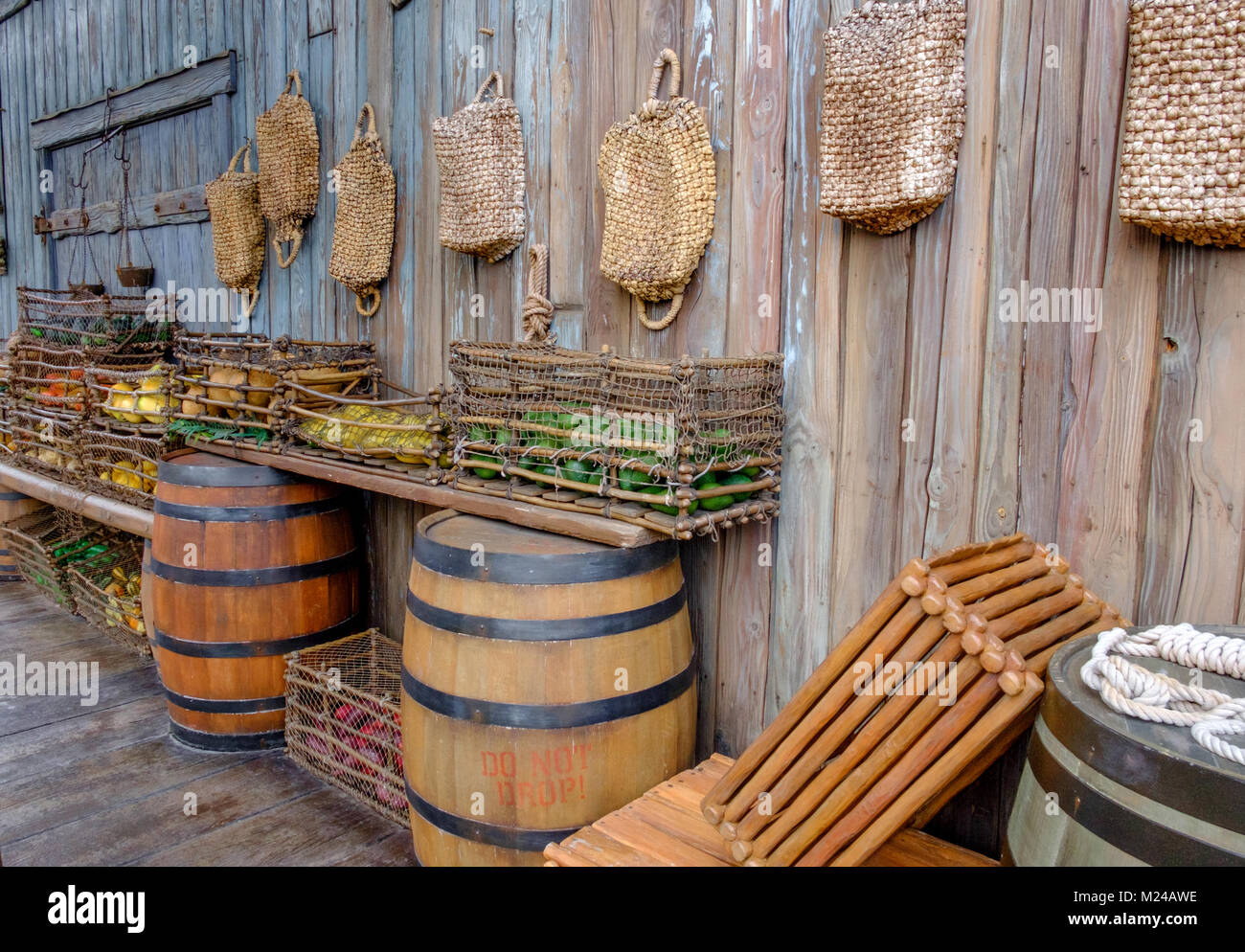 Old trading post with wooden walls, barrels, crates, baskets, scales ...