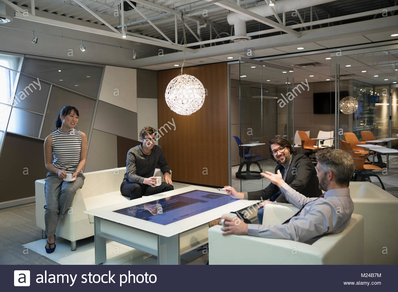 Group young people around table hi-res stock photography and images - Alamy