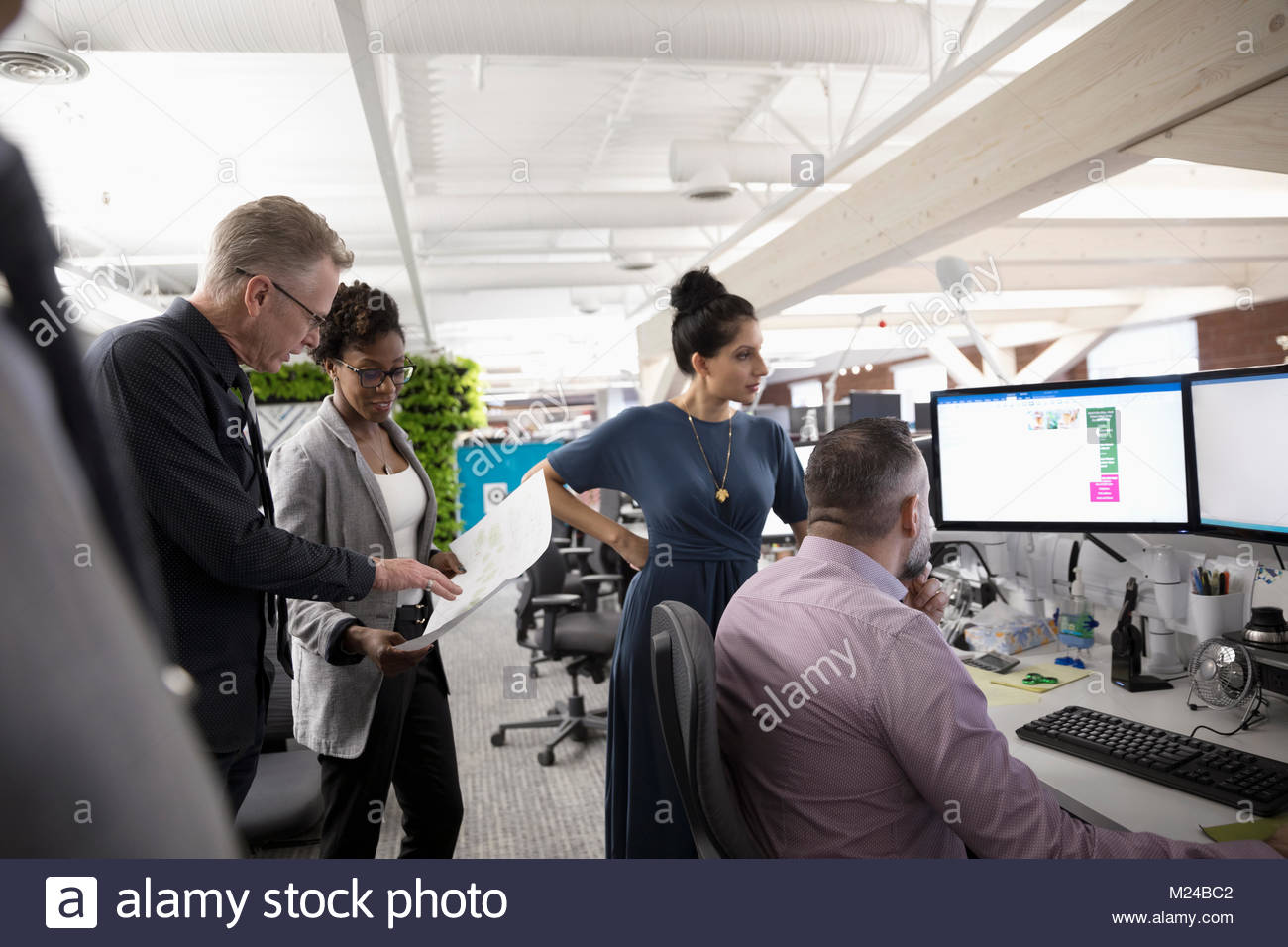 Business people working, meeting at computer in office cubicle Stock ...