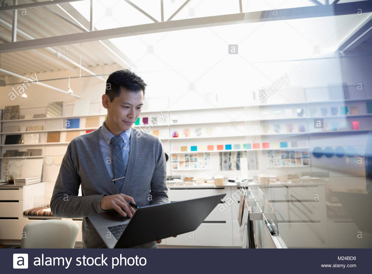Designer using laptop in creative office Stock Photo - Alamy