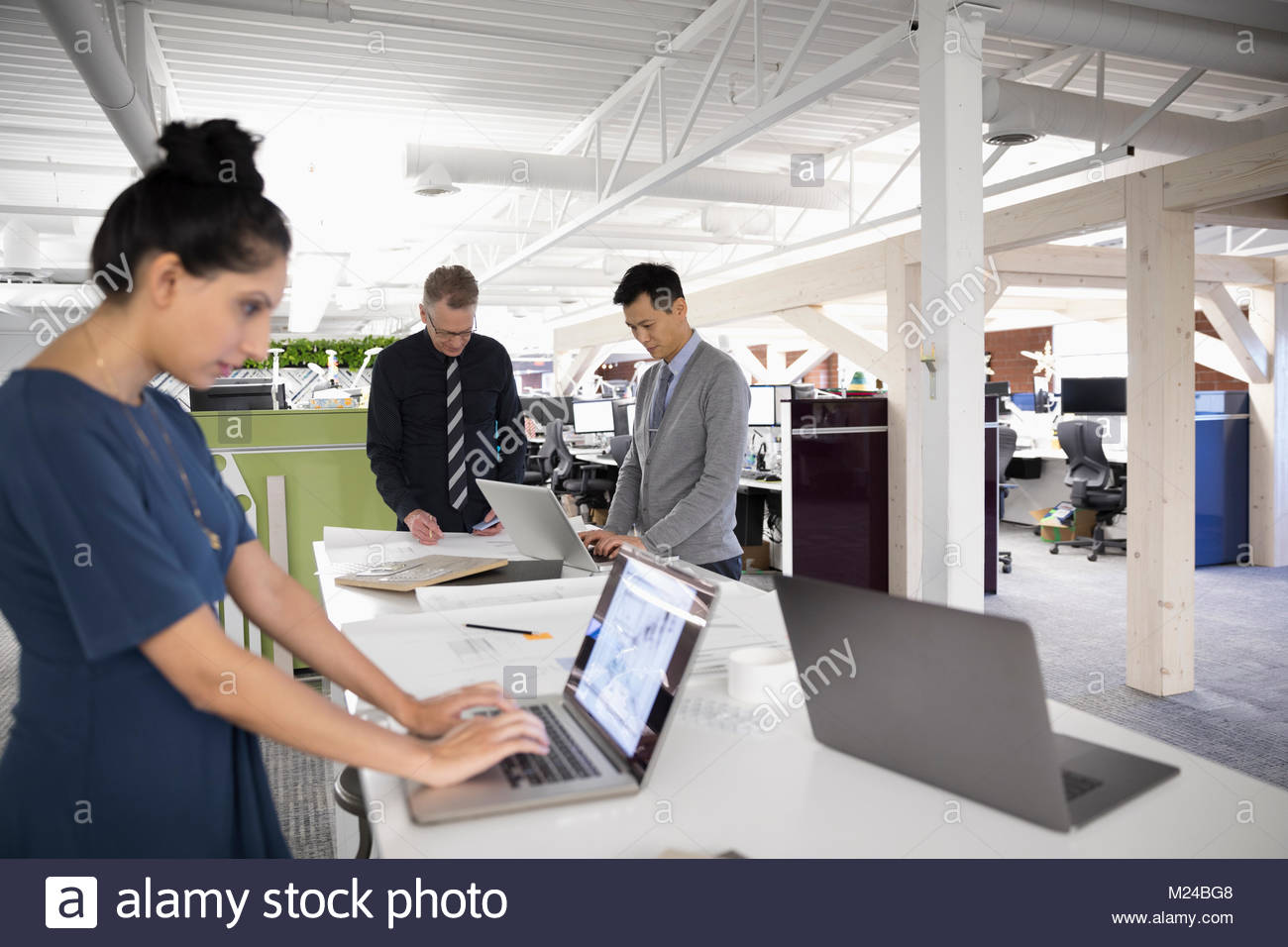 Architects working at laptops in office Stock Photo - Alamy