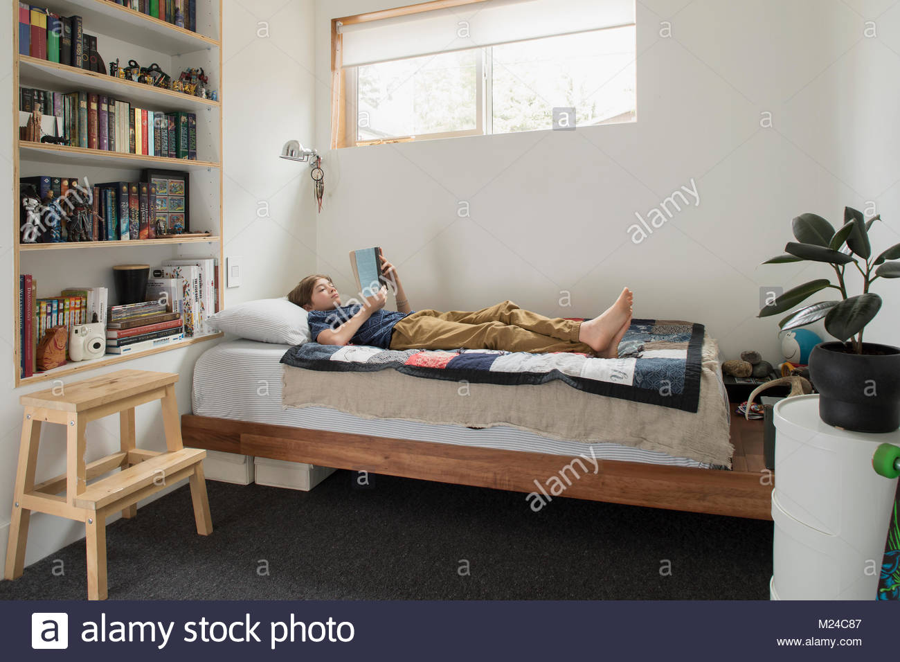 Teenager reading book indoors leisure hi-res stock photography and ...