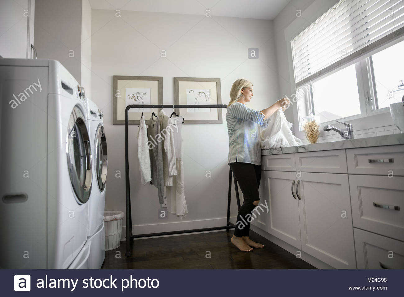 Woman in laundry room hi-res stock photography and images - Alamy