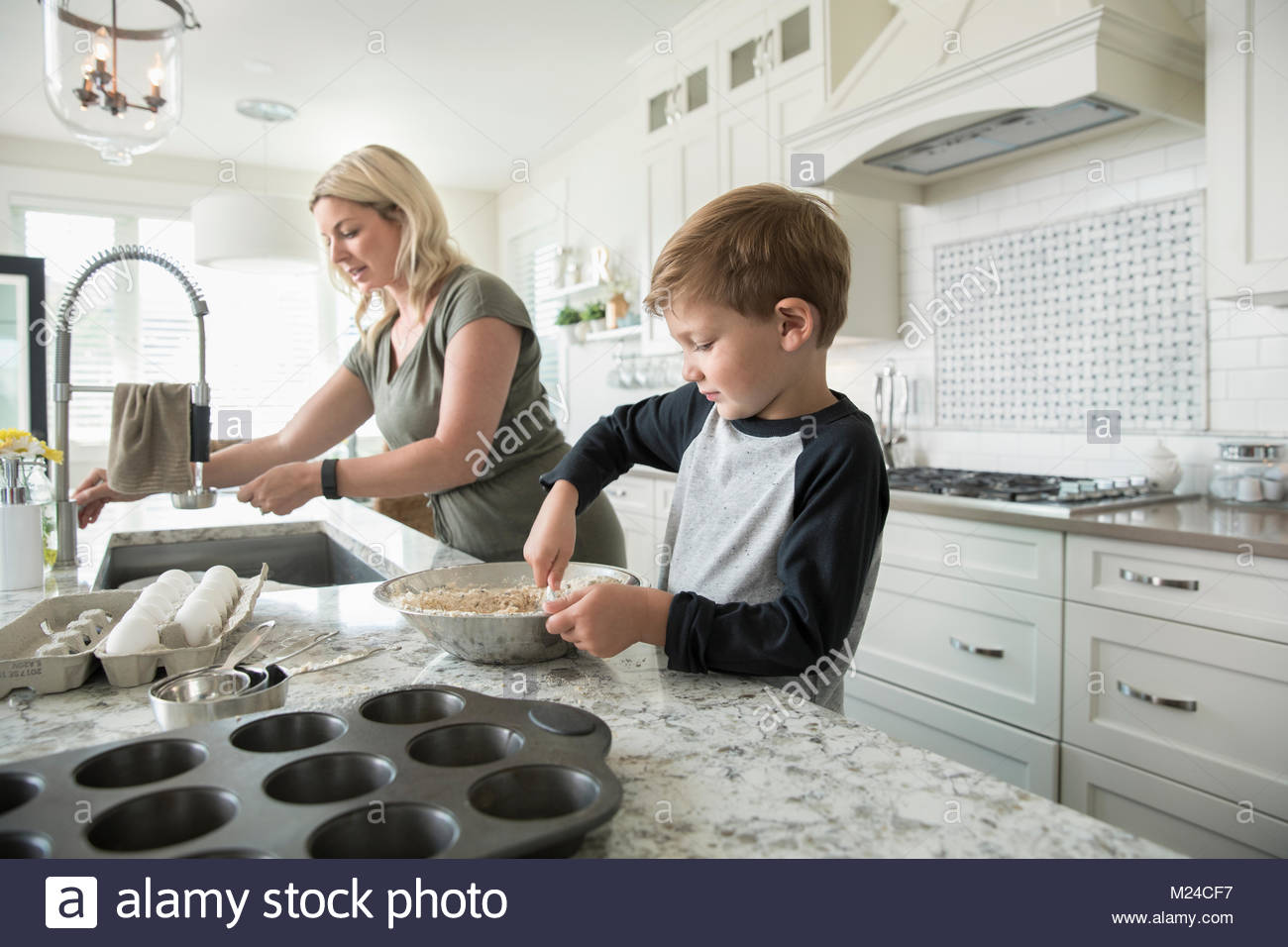 Mother and son baking muffins in kitchen Stock Photo - Alamy