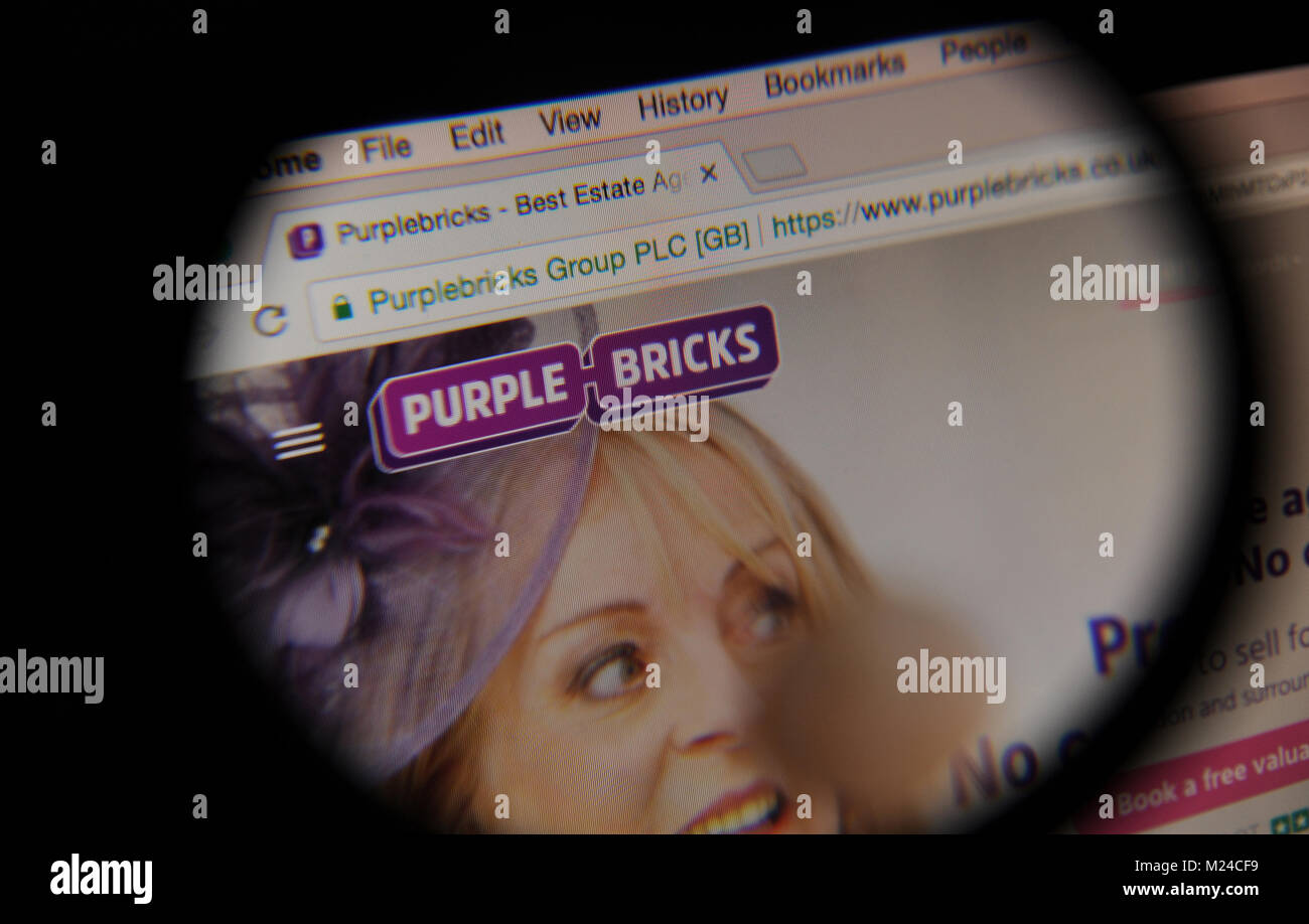 The PurpleBricks website seen through a magnifying glass Stock Photo ...