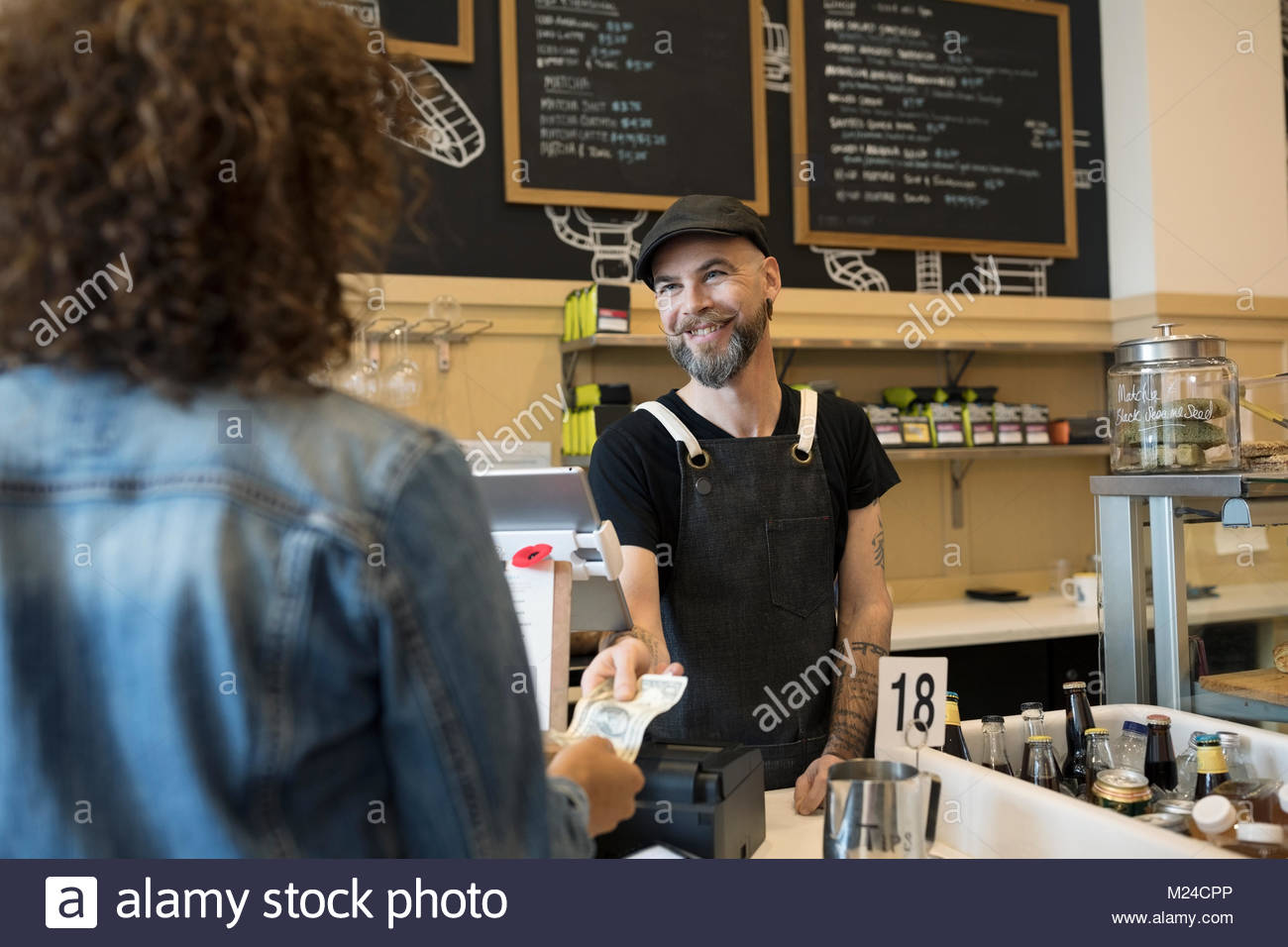 Female cashier giving money hi-res stock photography and images - Alamy