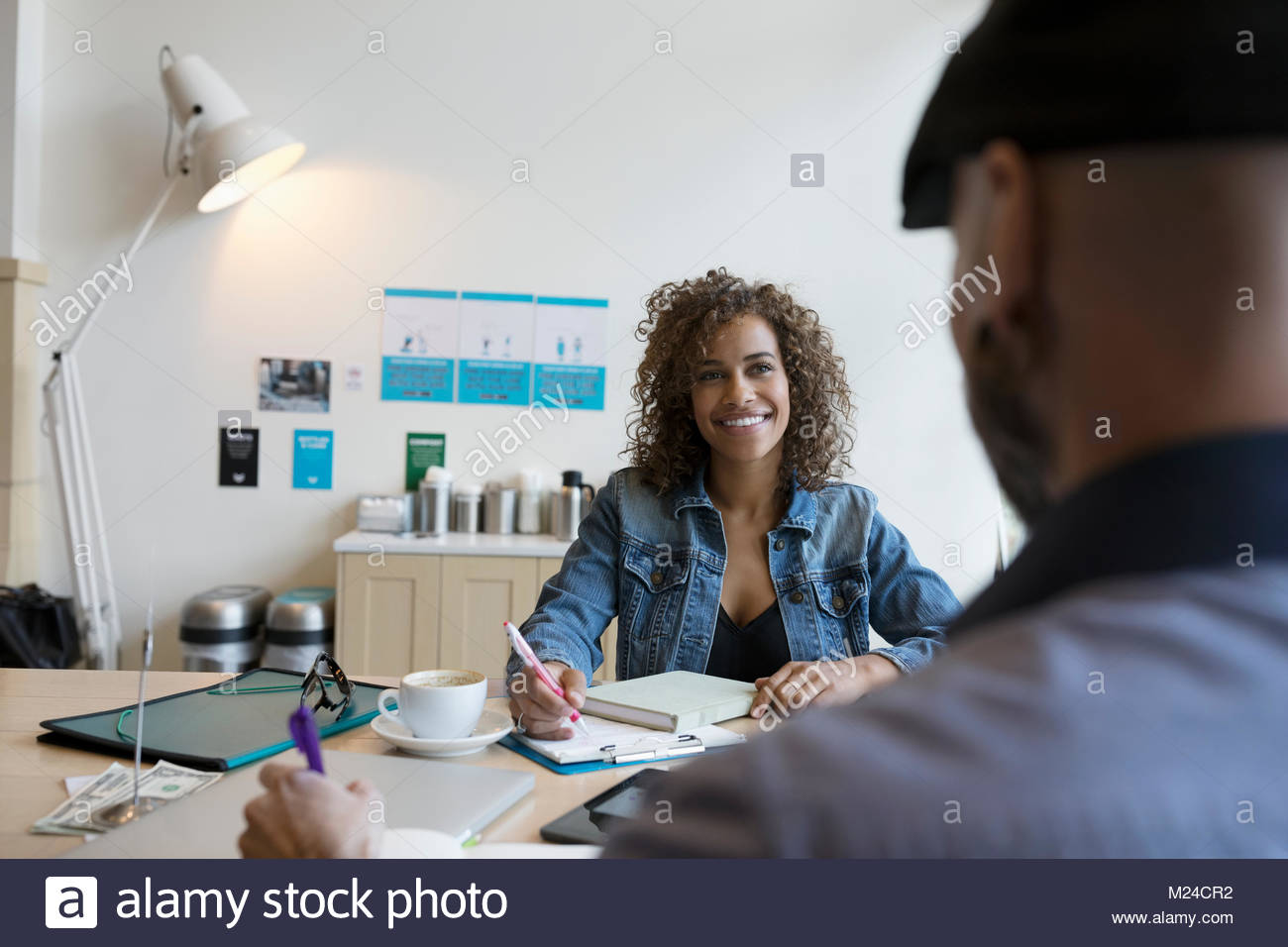 Smiling small business owners working, planning at table Stock Photo ...
