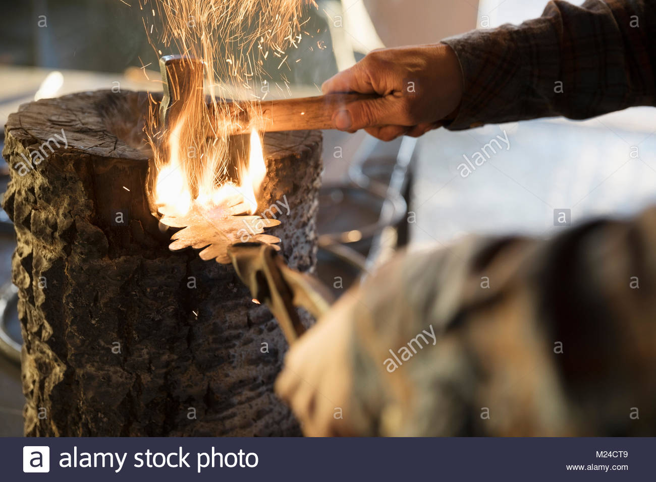Close up blacksmith heating metal over flame Stock Photo - Alamy
