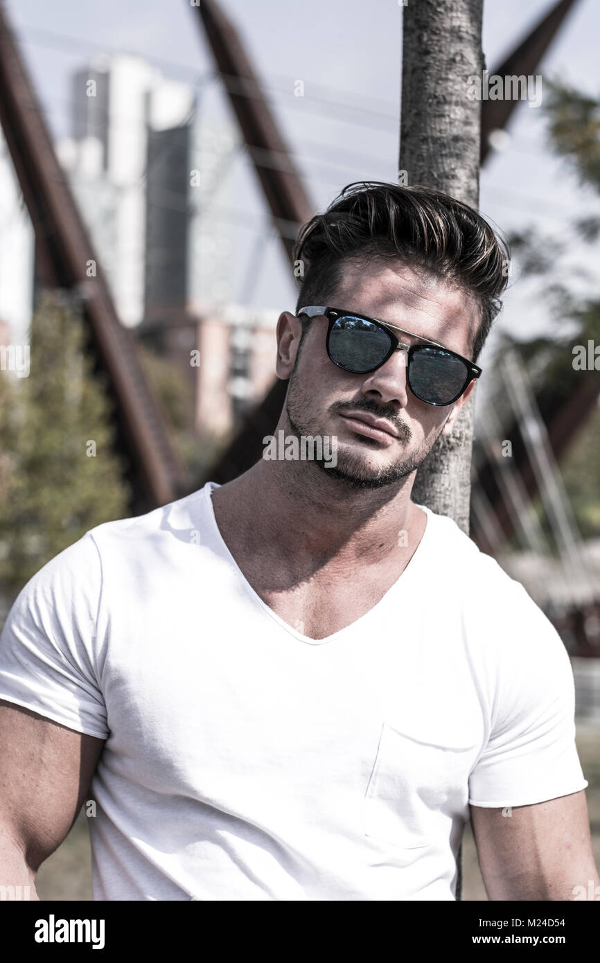 Man in urban setting in front of big metal structure Stock Photo - Alamy