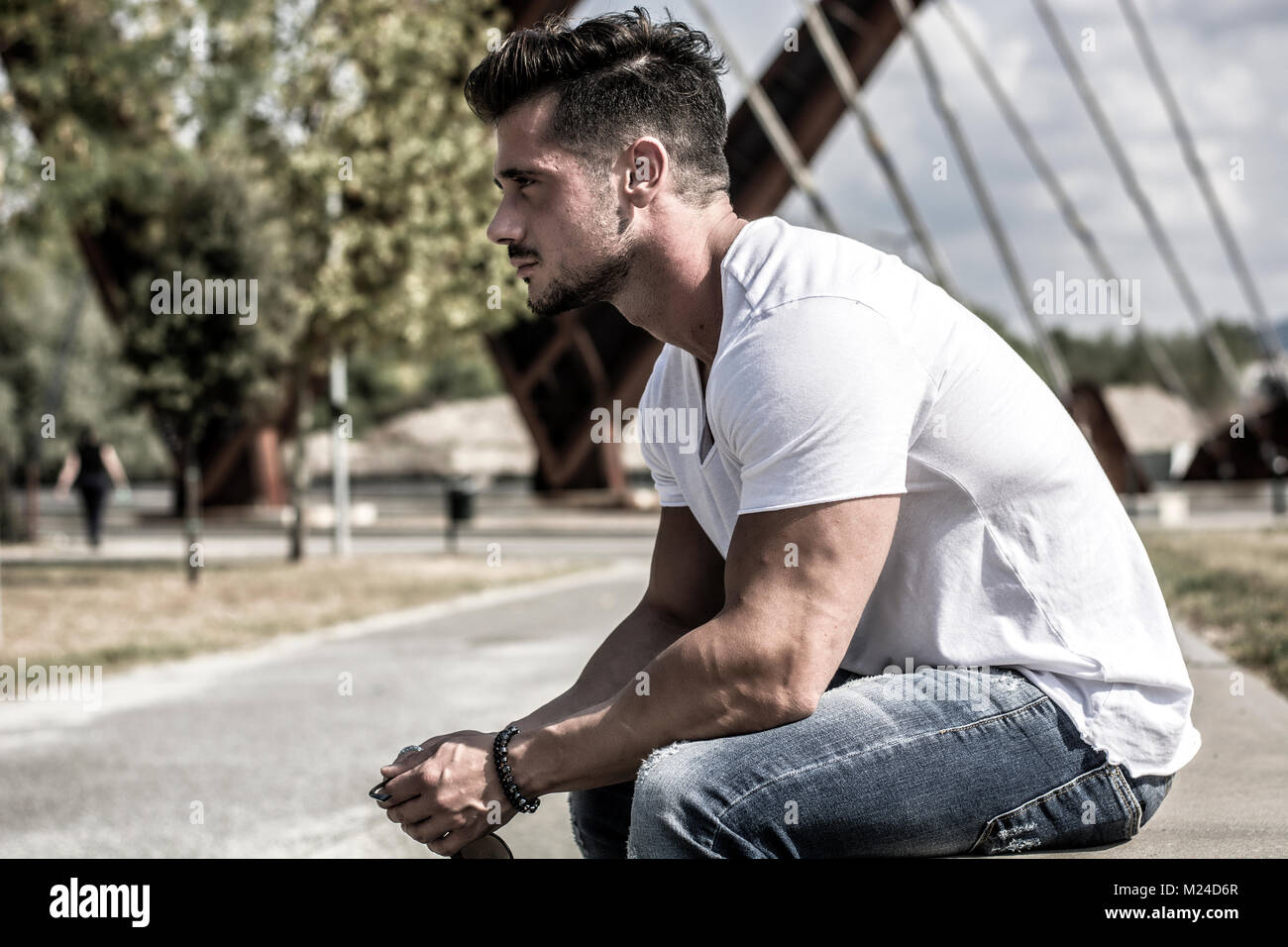 Man in urban setting in front of big metal structure Stock Photo - Alamy