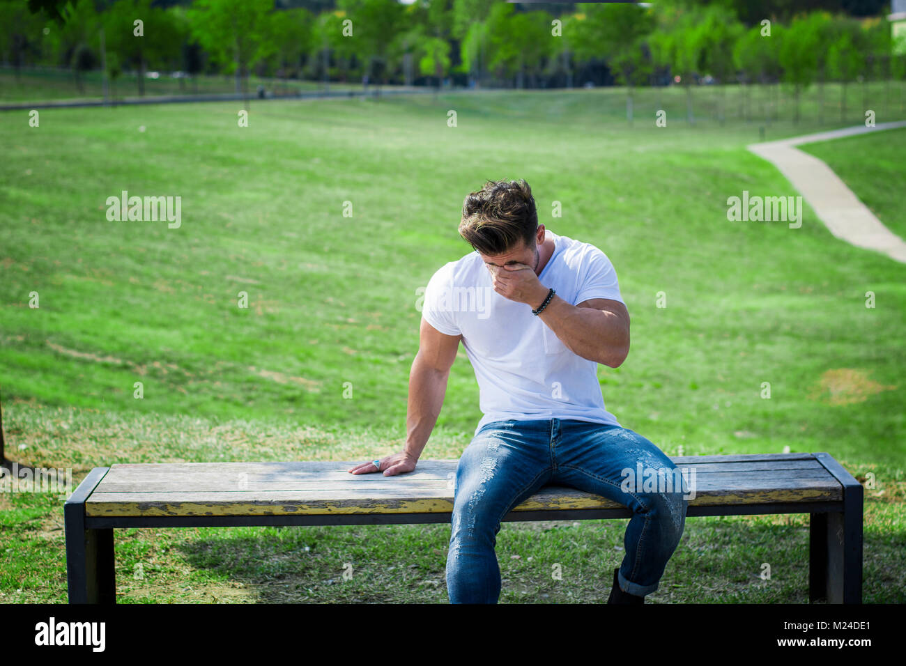 Man in city park crying on bench Stock Photo - Alamy