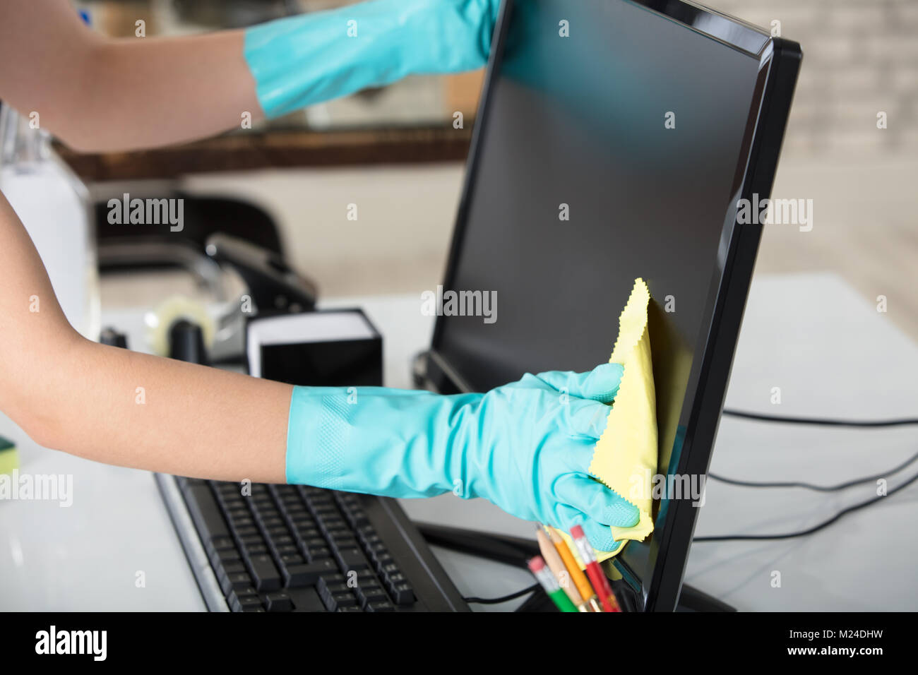 Close-up Of A Woman's Hand Cleaning The Desktop Screen With Yellow Rag ...