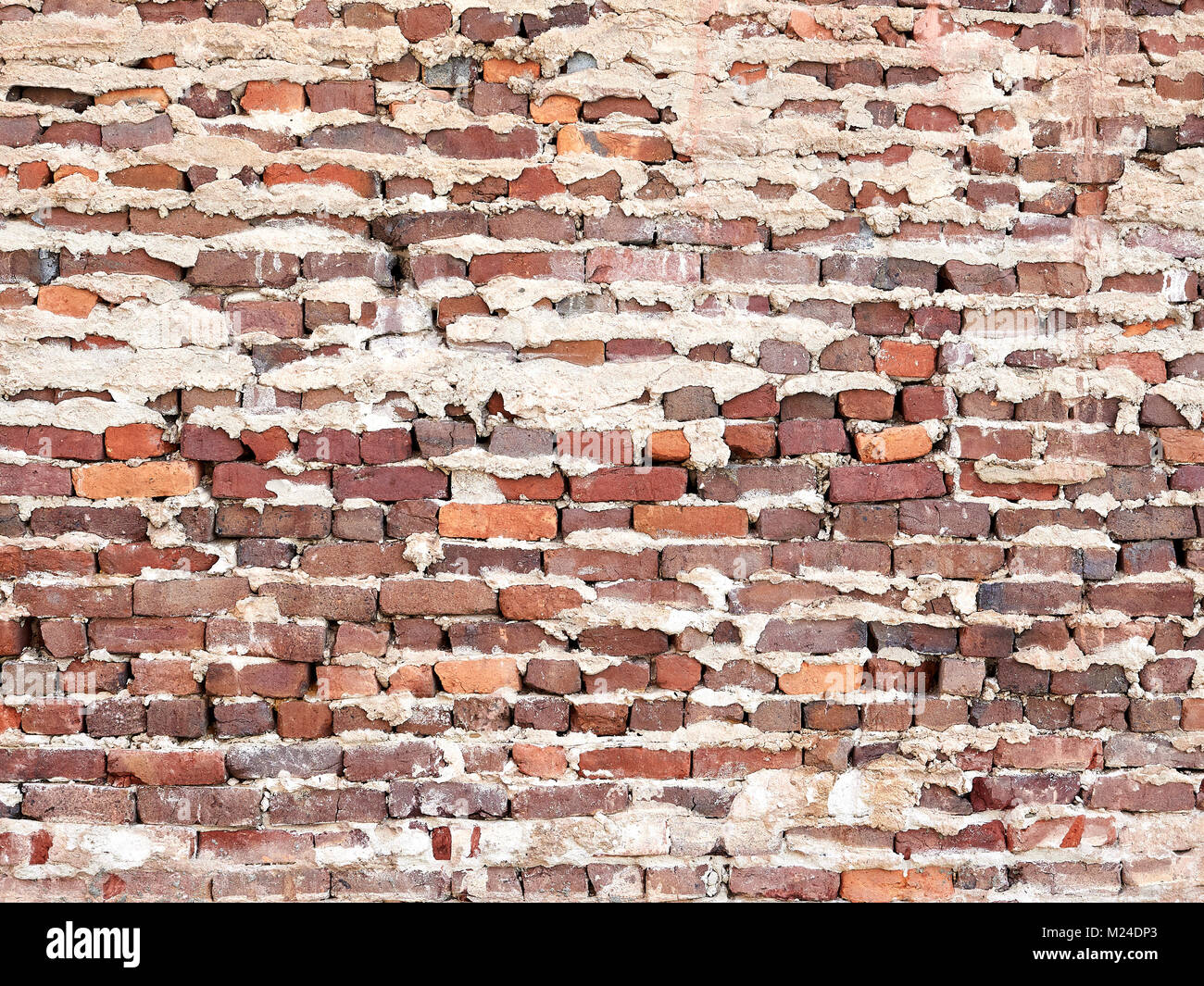 Old weathered cracked and damaged brick background in a pattern with ...