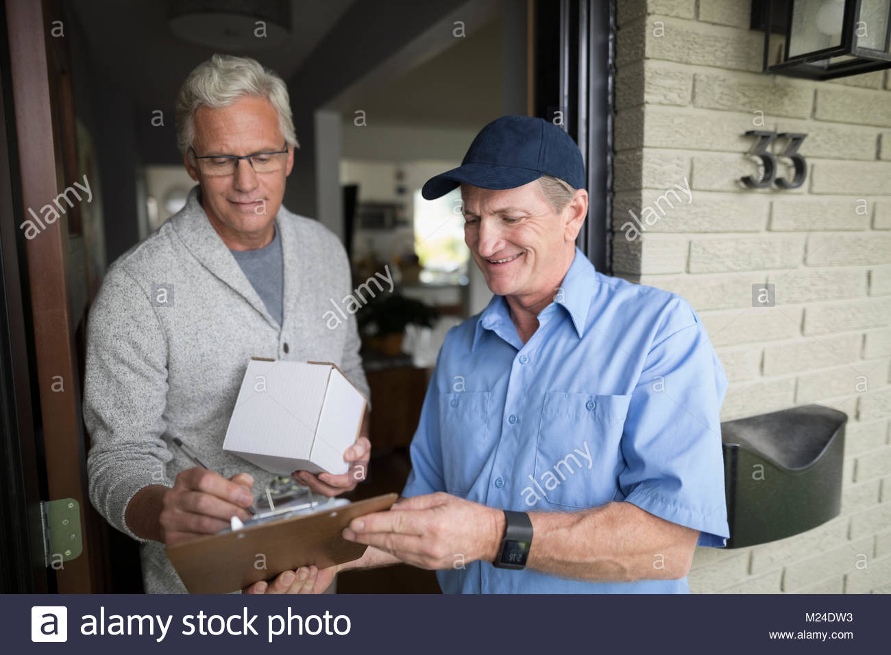 Signing for package hi-res stock photography and images - Alamy