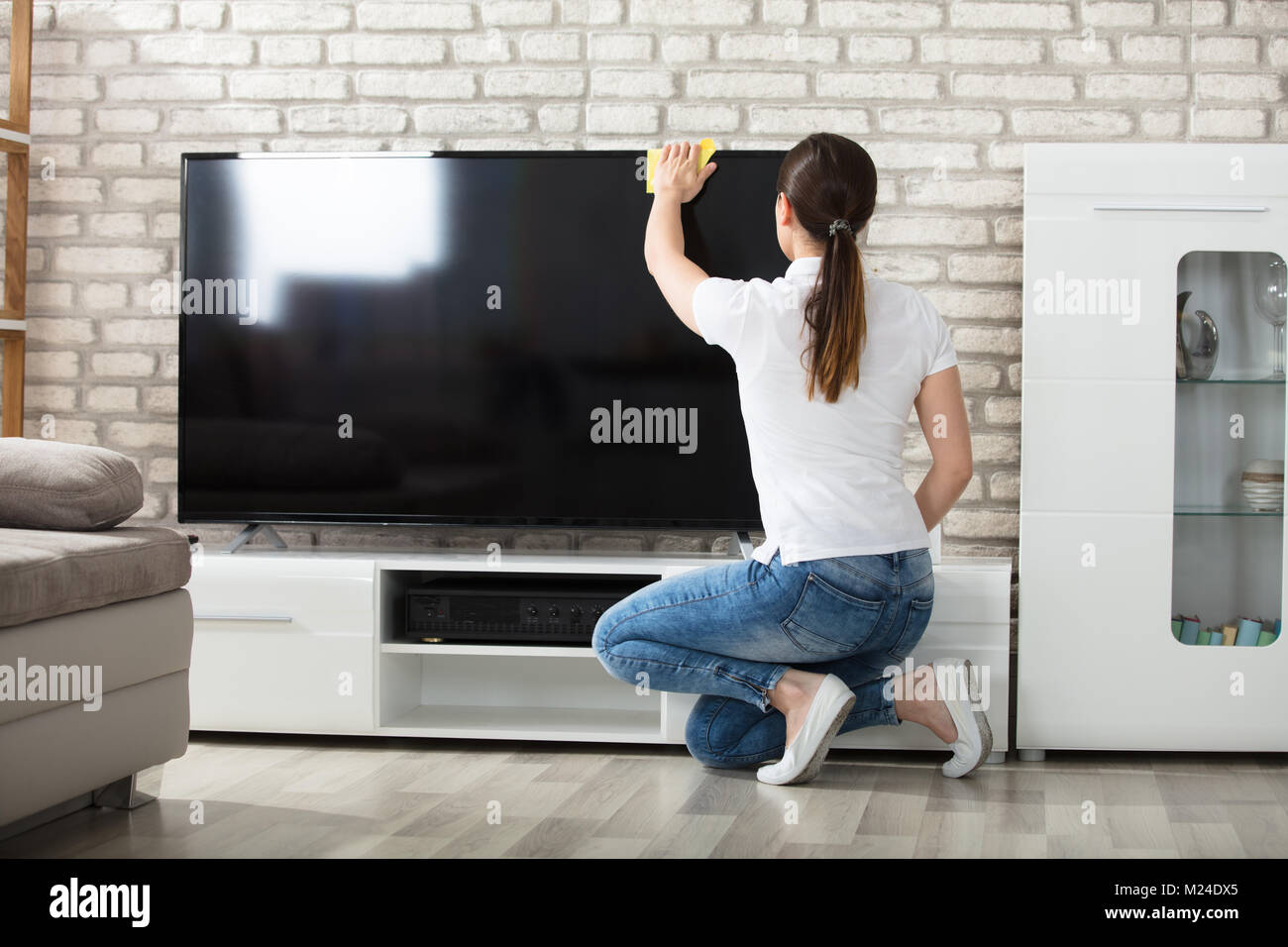Woman cleaning screen television in hi-res stock photography and images ...