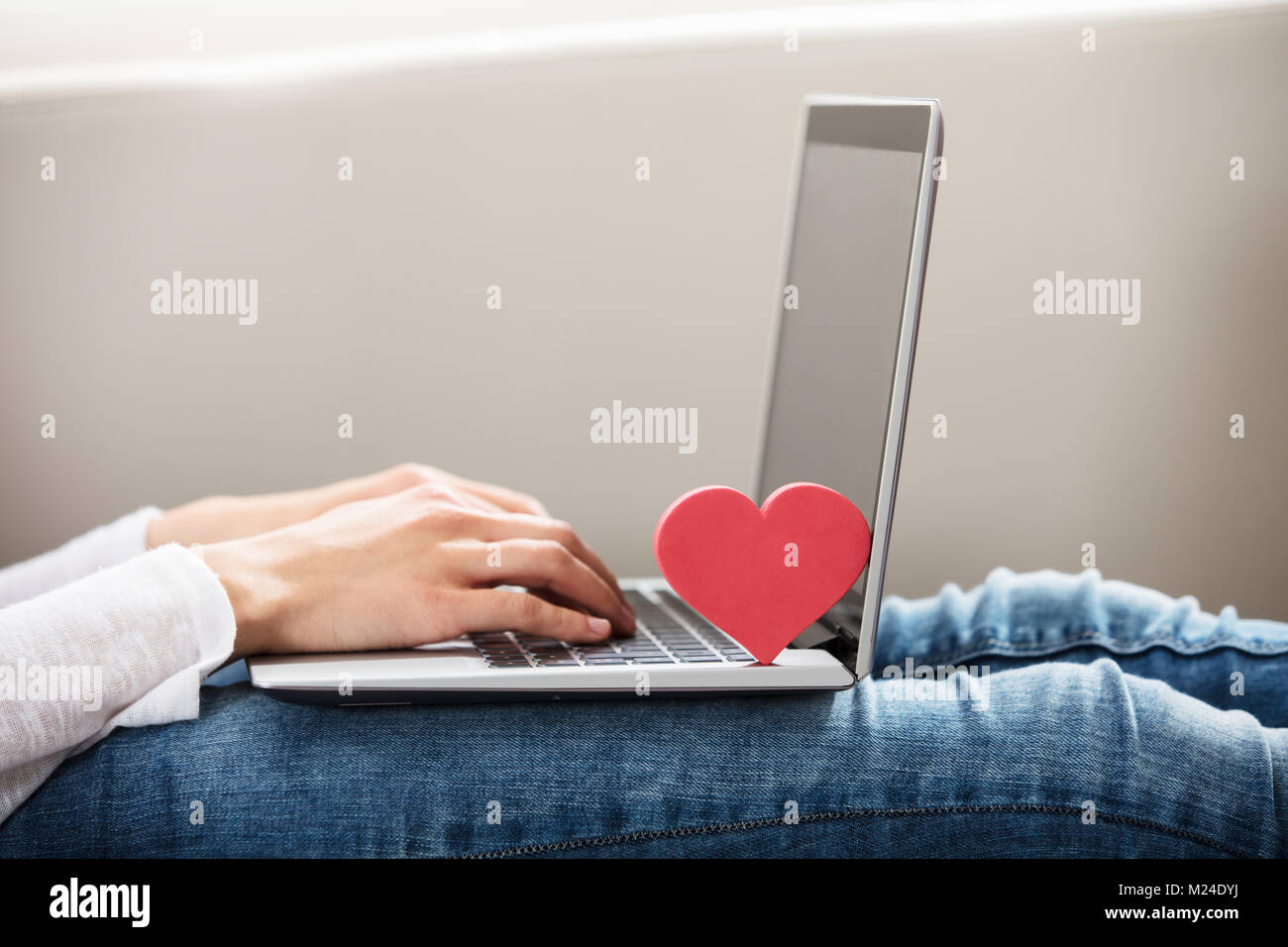 Heart Shape On Laptop Over The Woman's Lap Stock Photo - Alamy