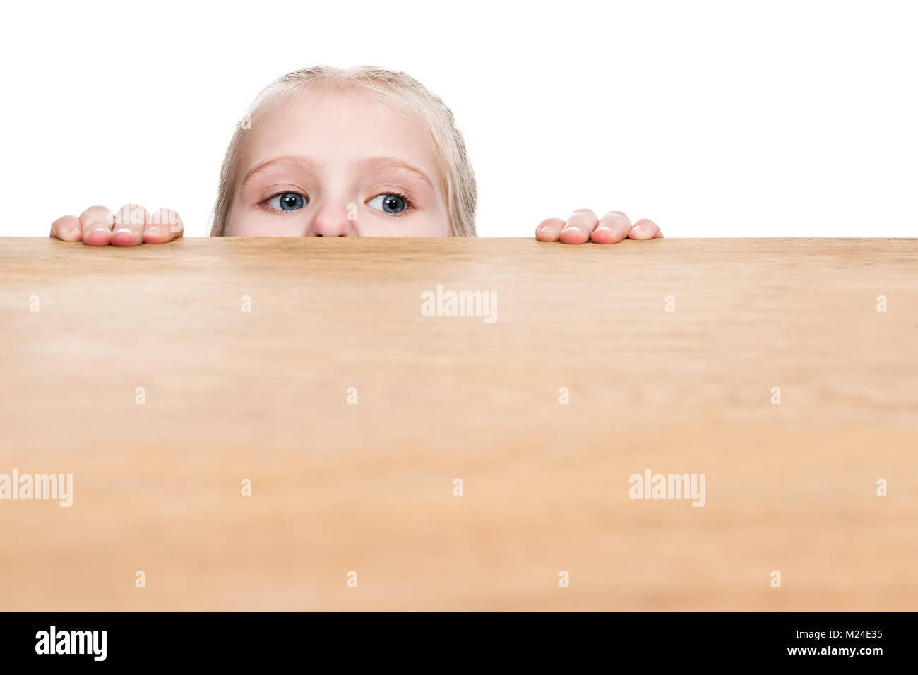 Child looks out from under the table Stock Photo - Alamy
