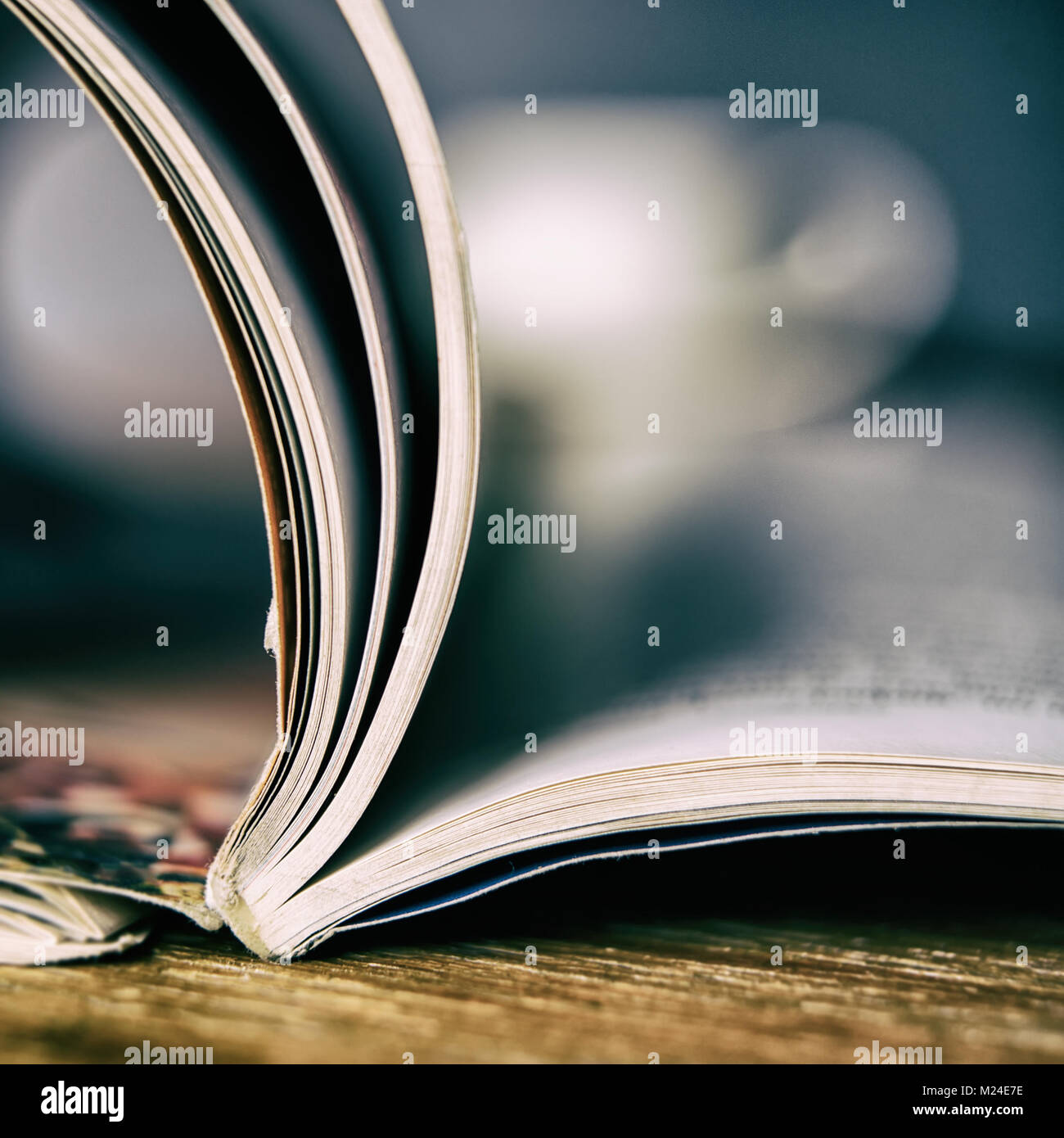 open magazine on a blurry background with a cup of coffee.The magazine ...