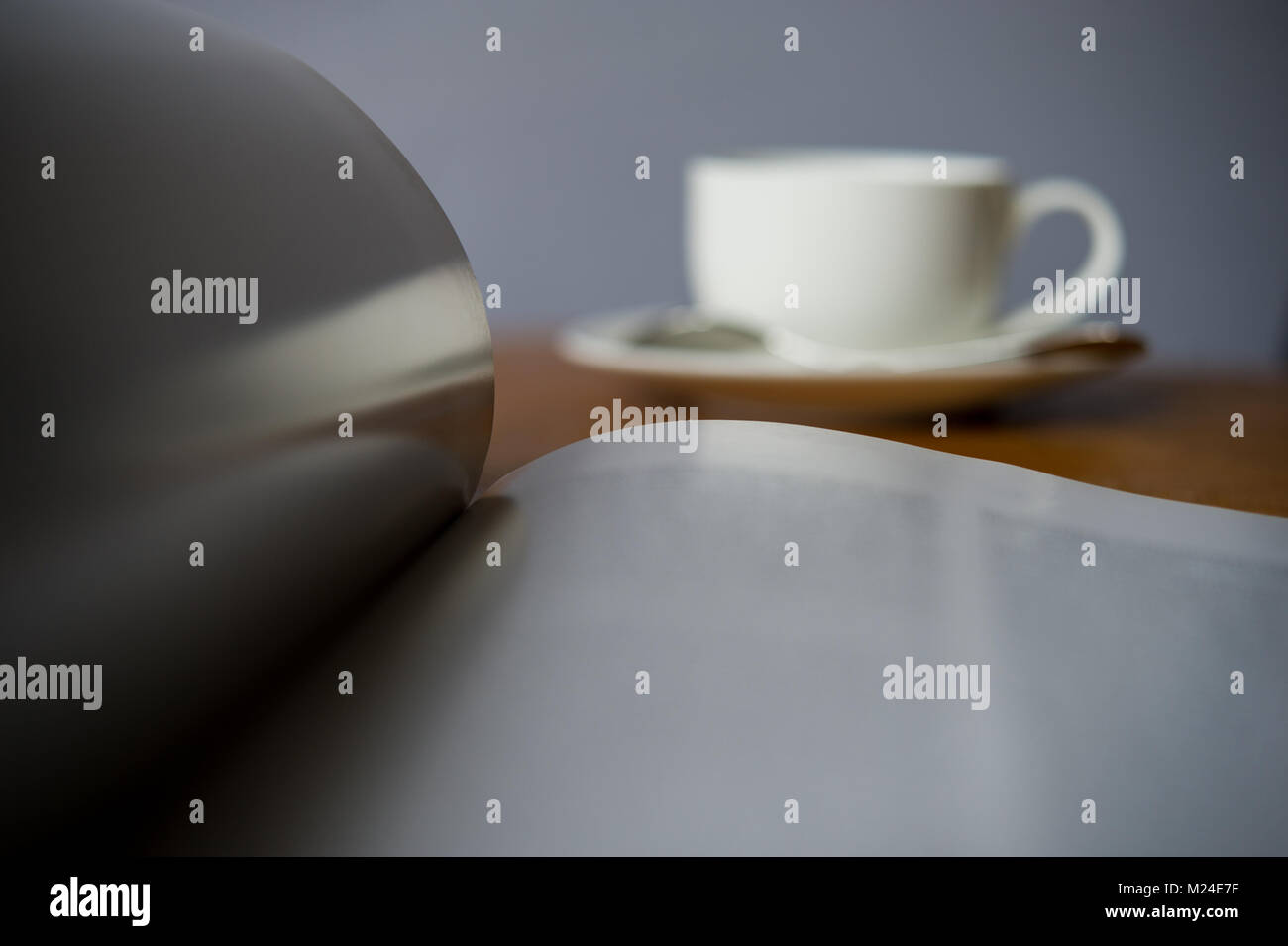 open magazine on a blurry background with a cup of coffee.The magazine ...