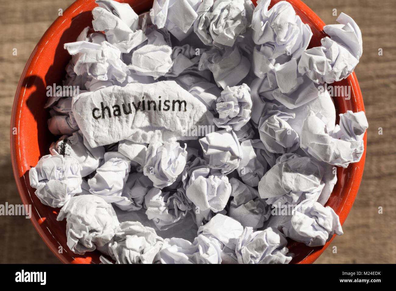 Crumpled paper written chauvism inside the trash can. Paper balls. Old ...